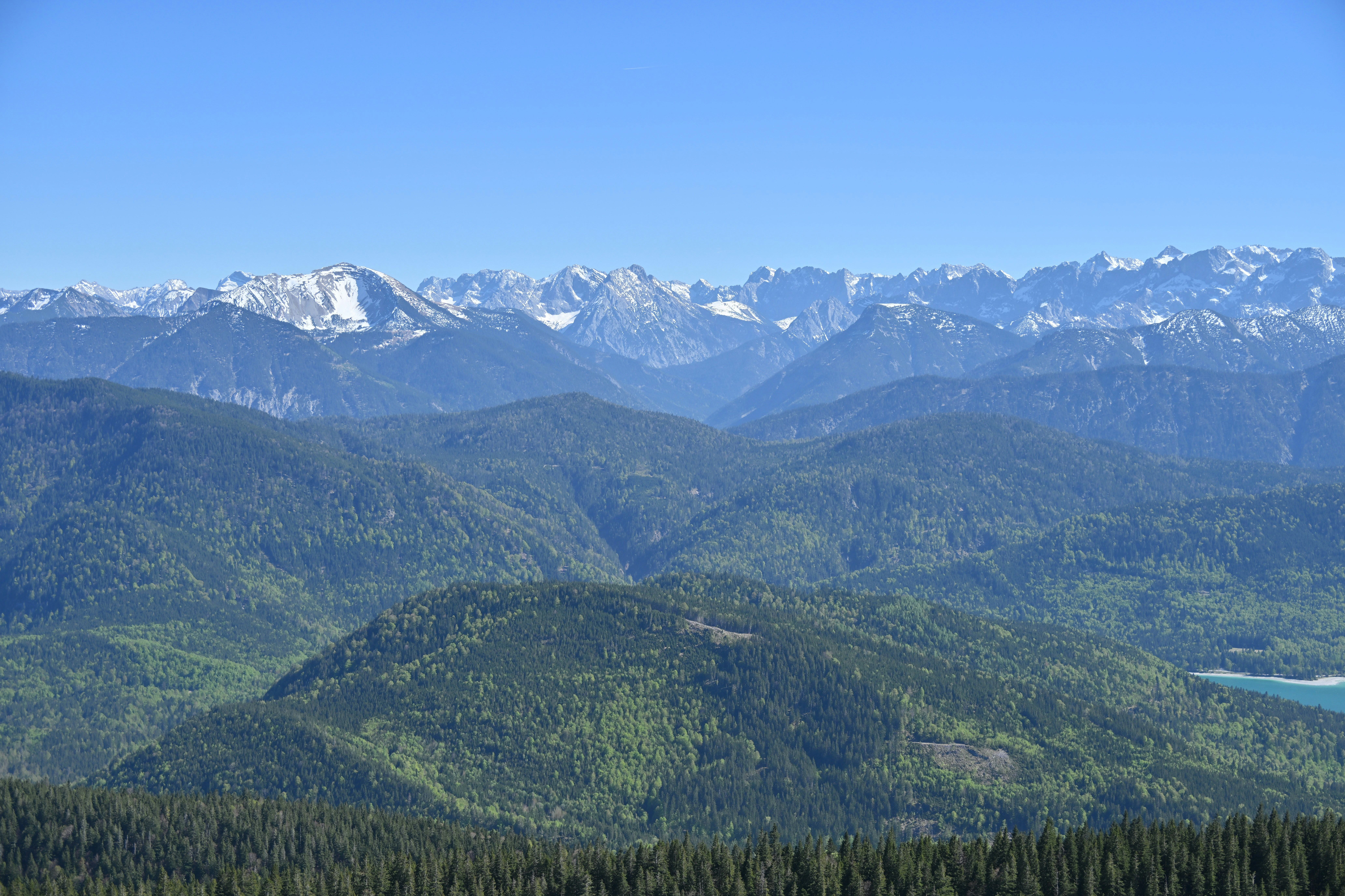 Snow-kissed peaks over layered foothills