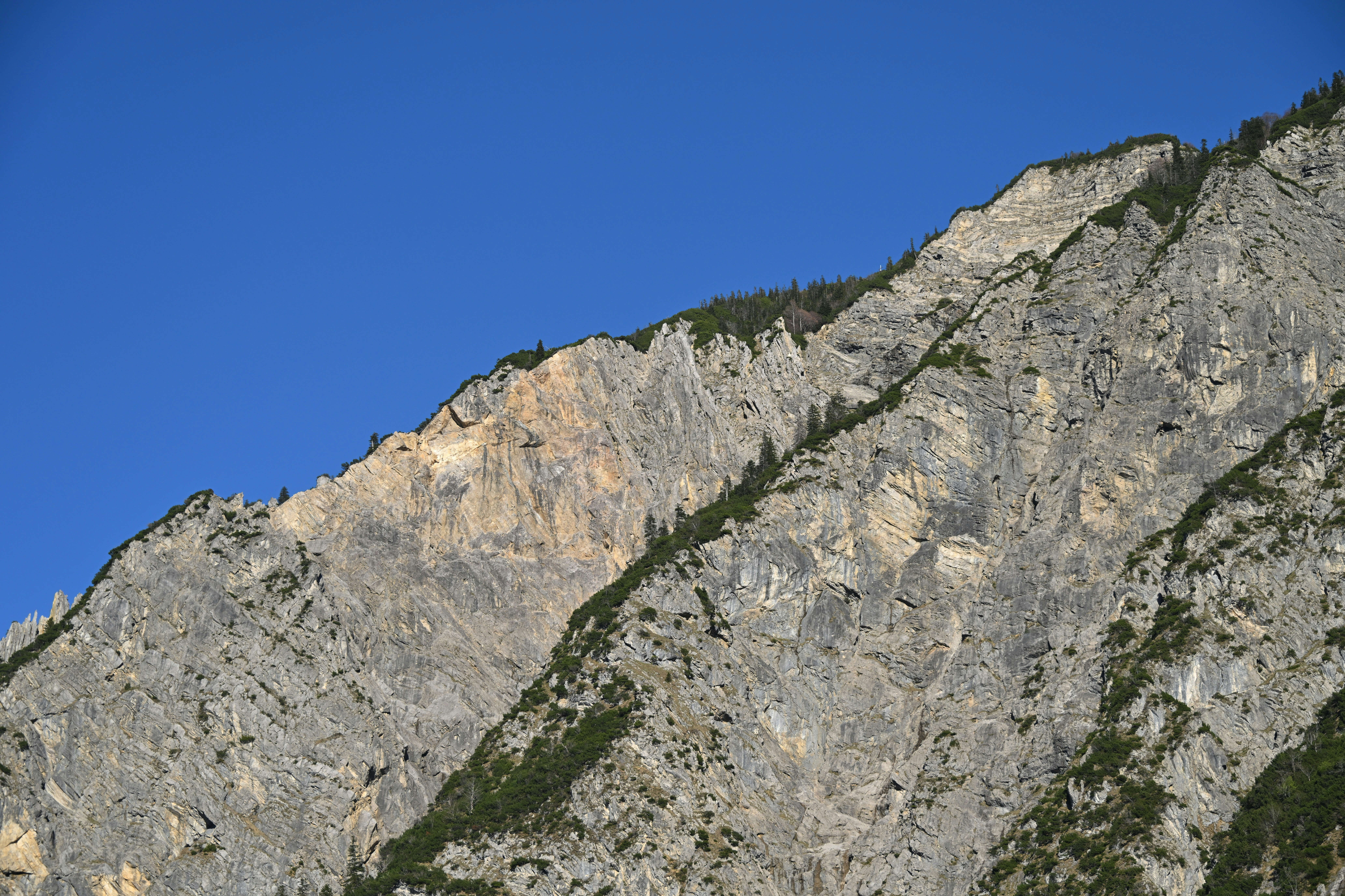 Cragline under a Piercing Blue: Mountain Facade in Bright Daylight