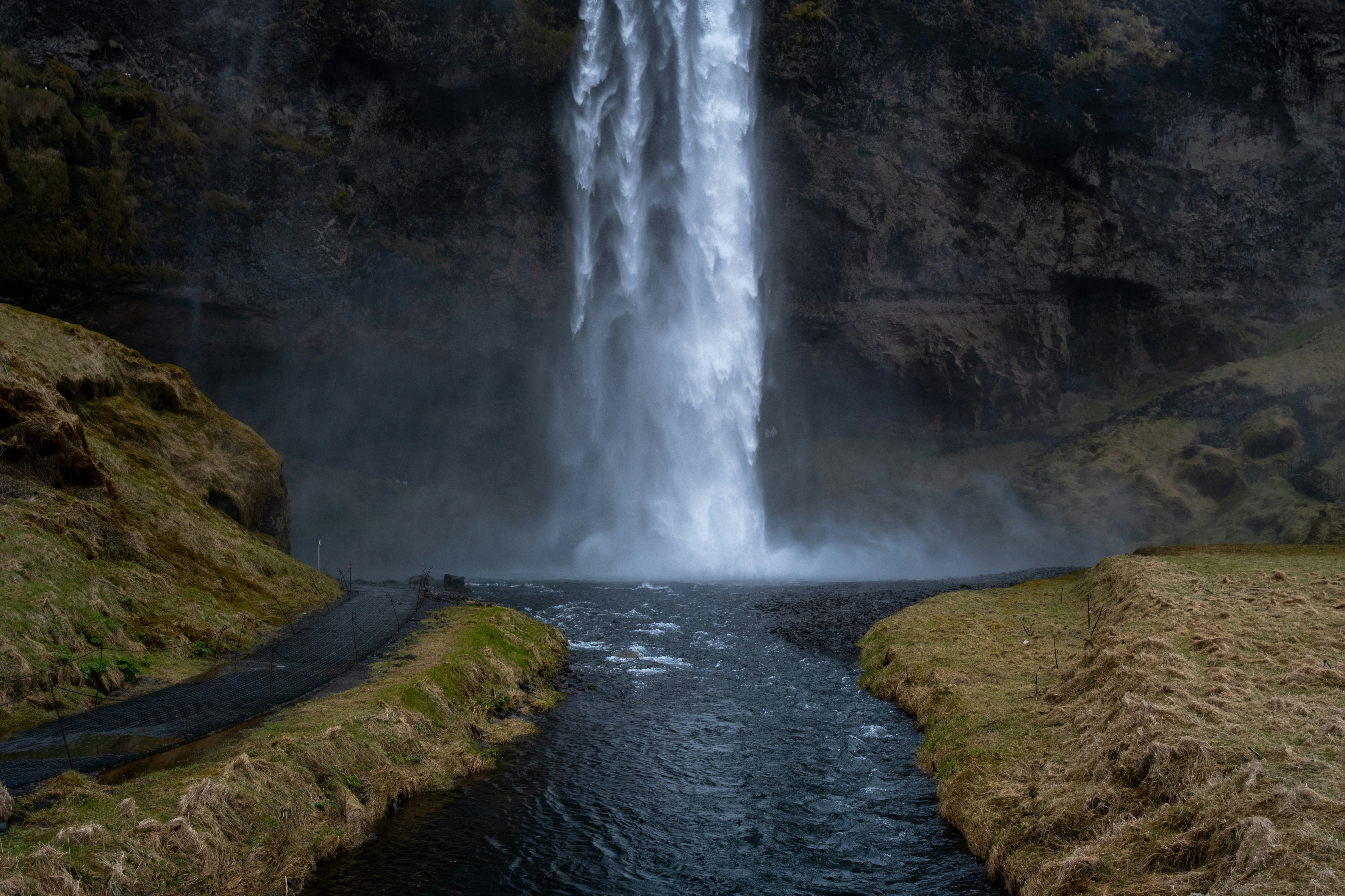 Cascading Veil: Narrow Path Framing a Waterfall