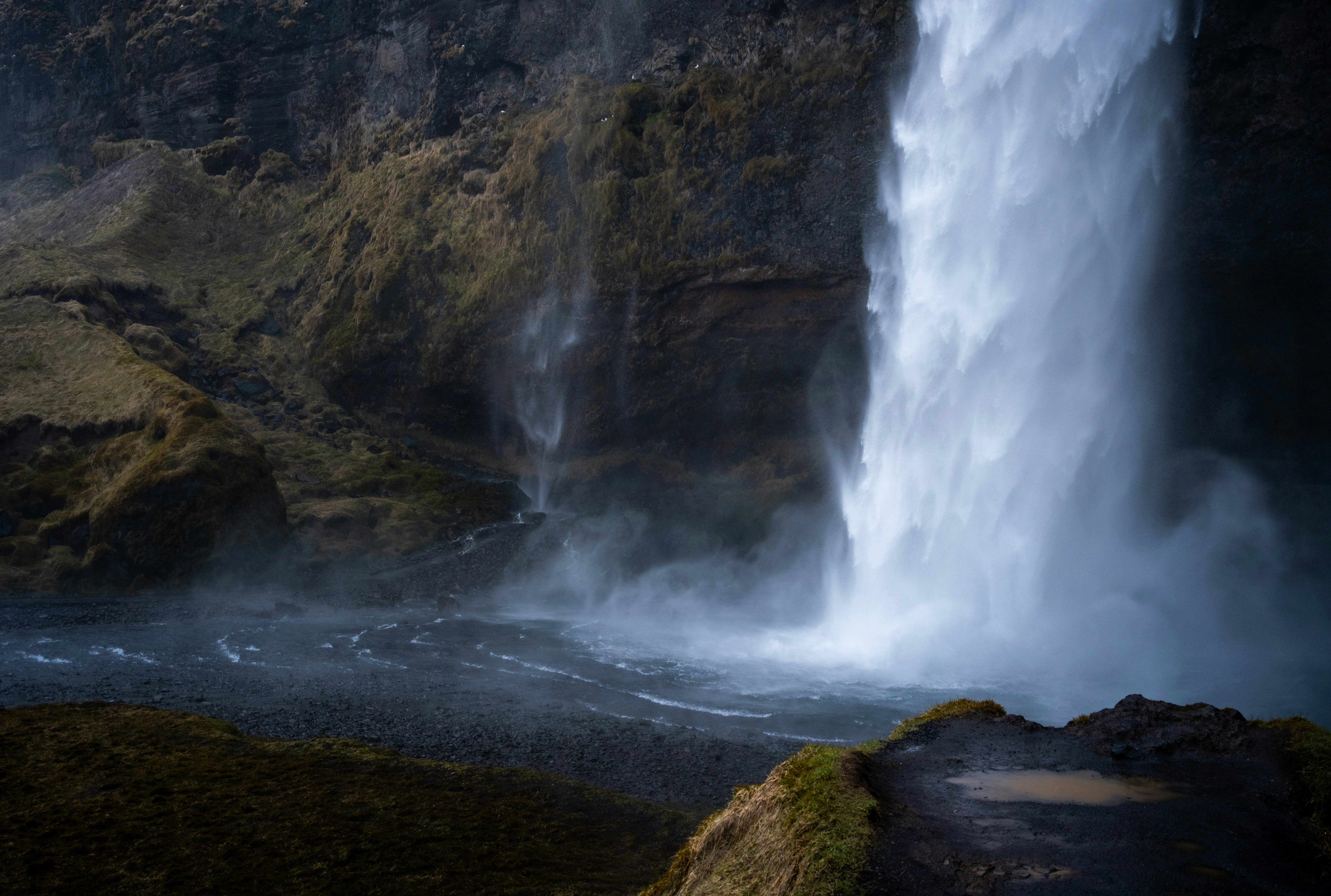 Mist Curtain at the Edge: A Narrow Canyon Waterfall