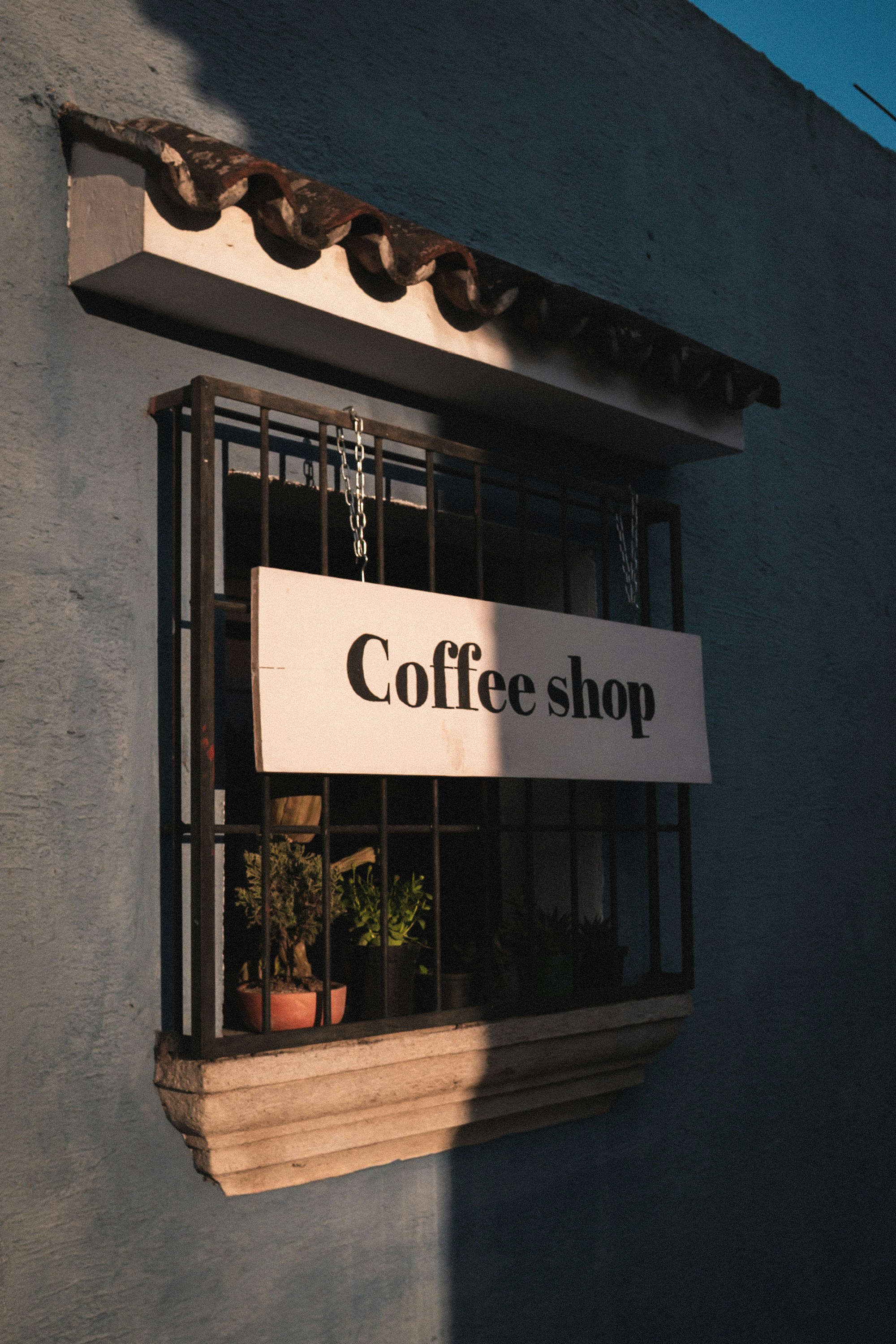 Coffee Shop Sign in a Quiet Blue Facade