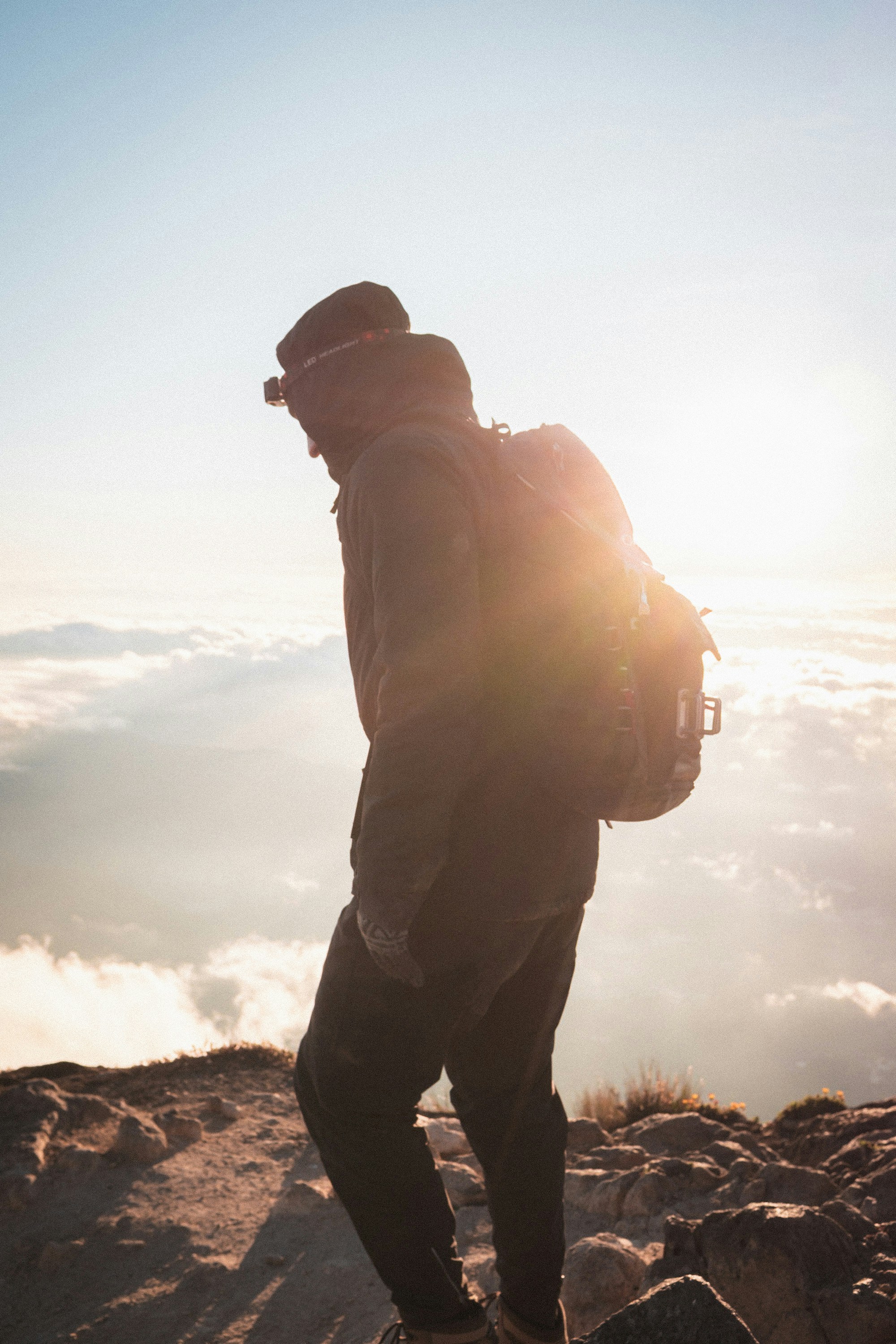 Backlit Summit Trekker at Dawn