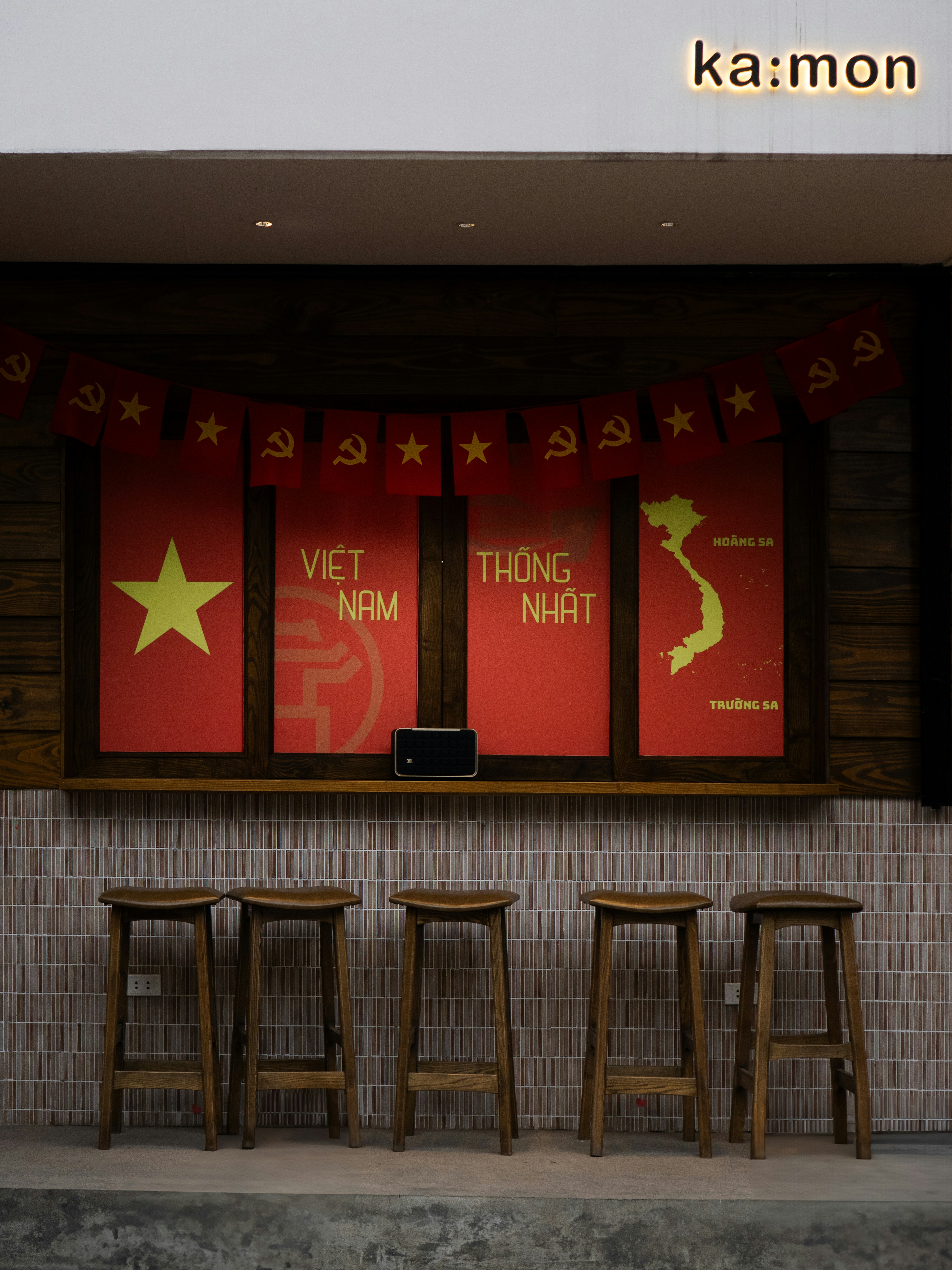 Vietnamese Café Night: Red Panels and Stool silhouettes