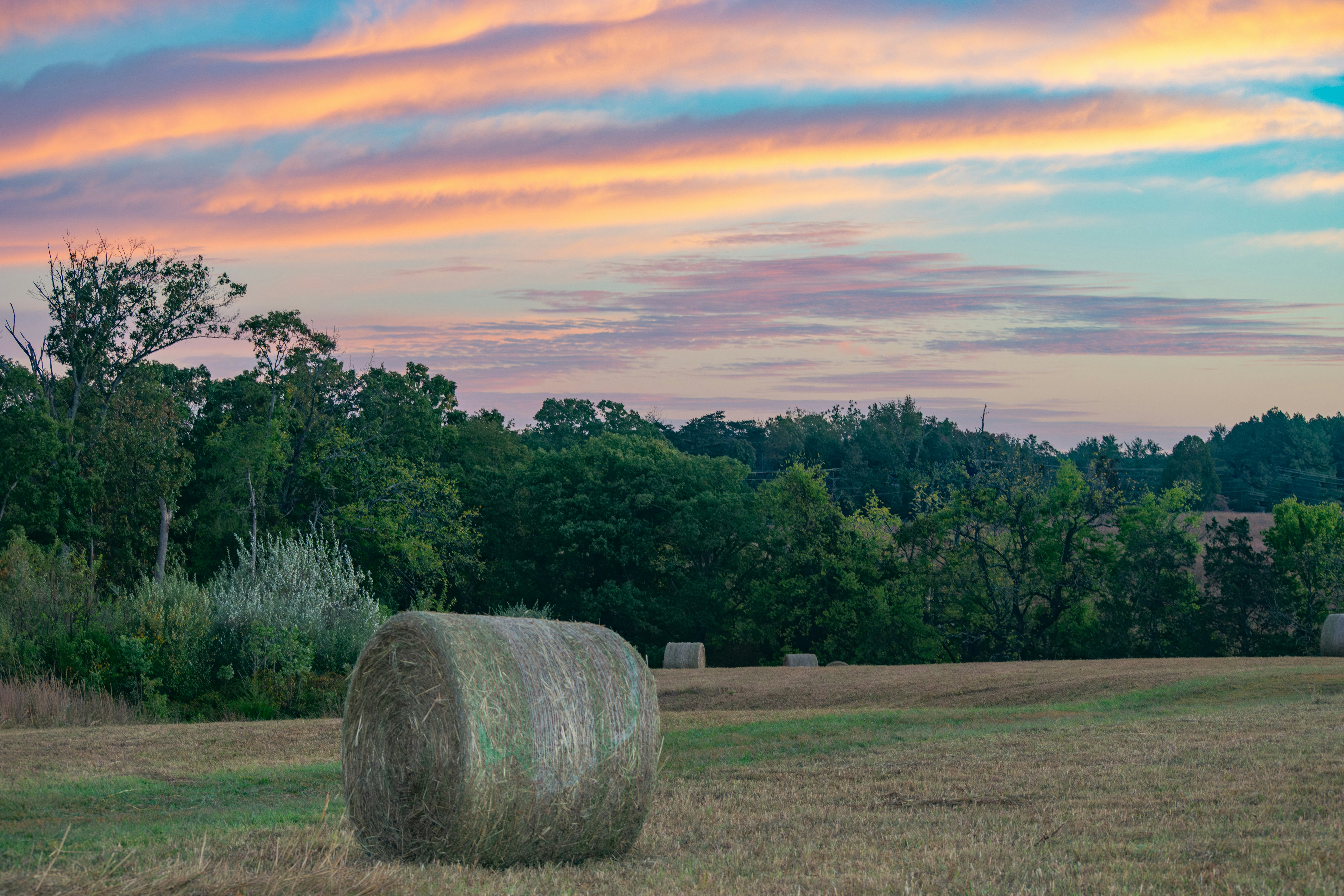 Sunset Field with a Rolled Hay Bale