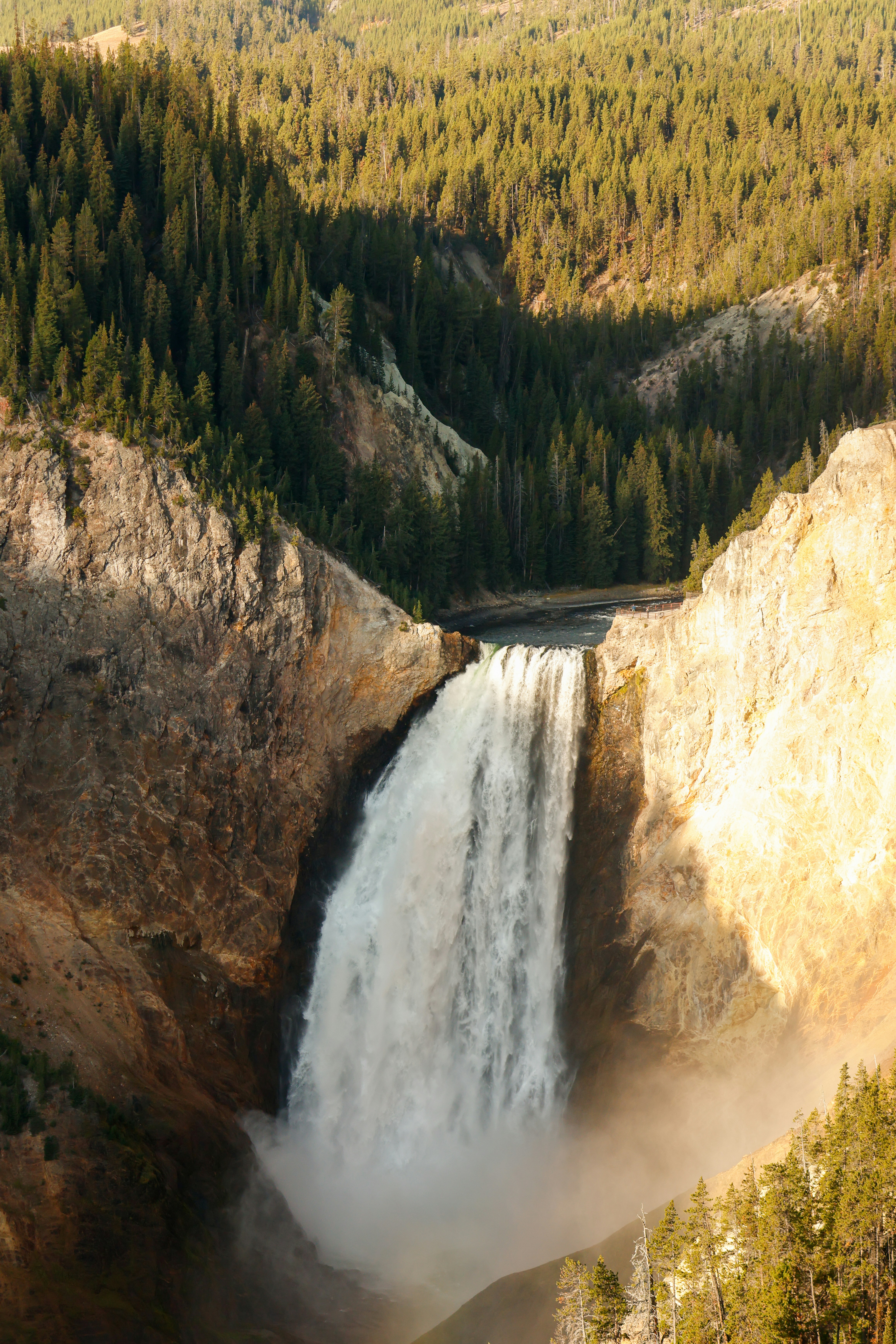 Cascade Veil: Sunlit Canyon Falls Between Golden Cliffs