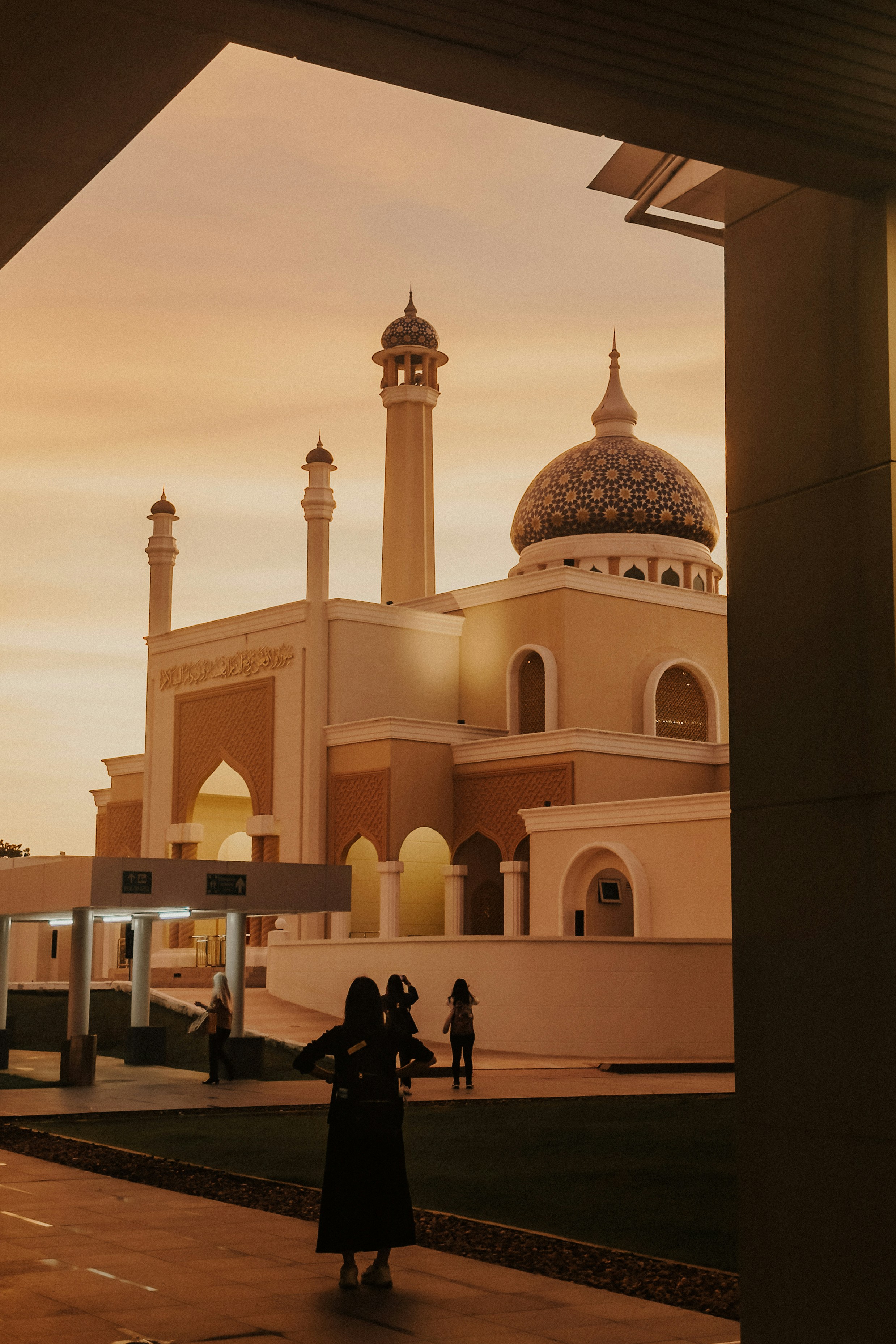 Golden Hour Minarets and Dome: Mosque Courtyard Behind the Frame