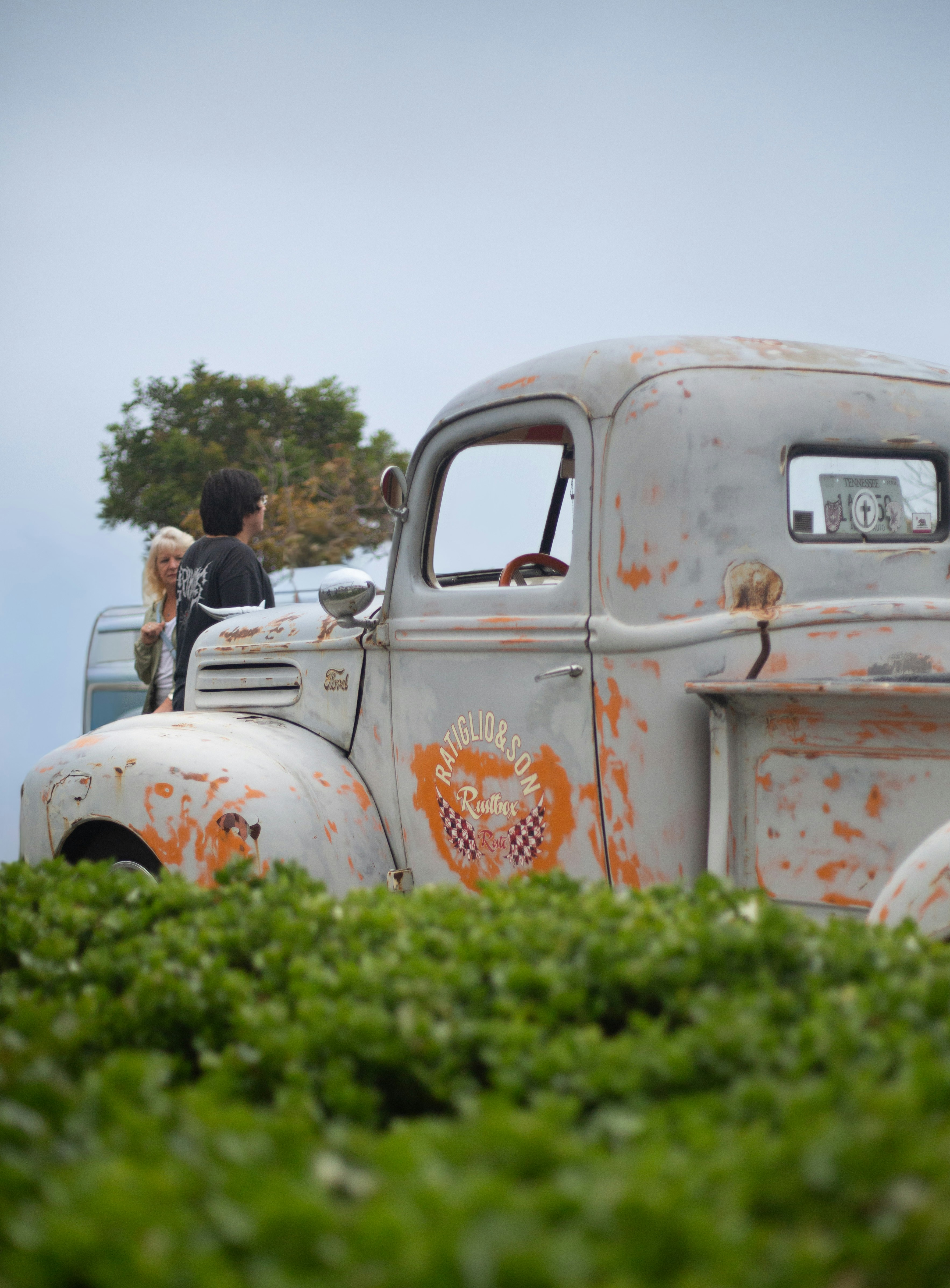 Rusty Road Warrior: A Vintage Truck and Attentive Crowd