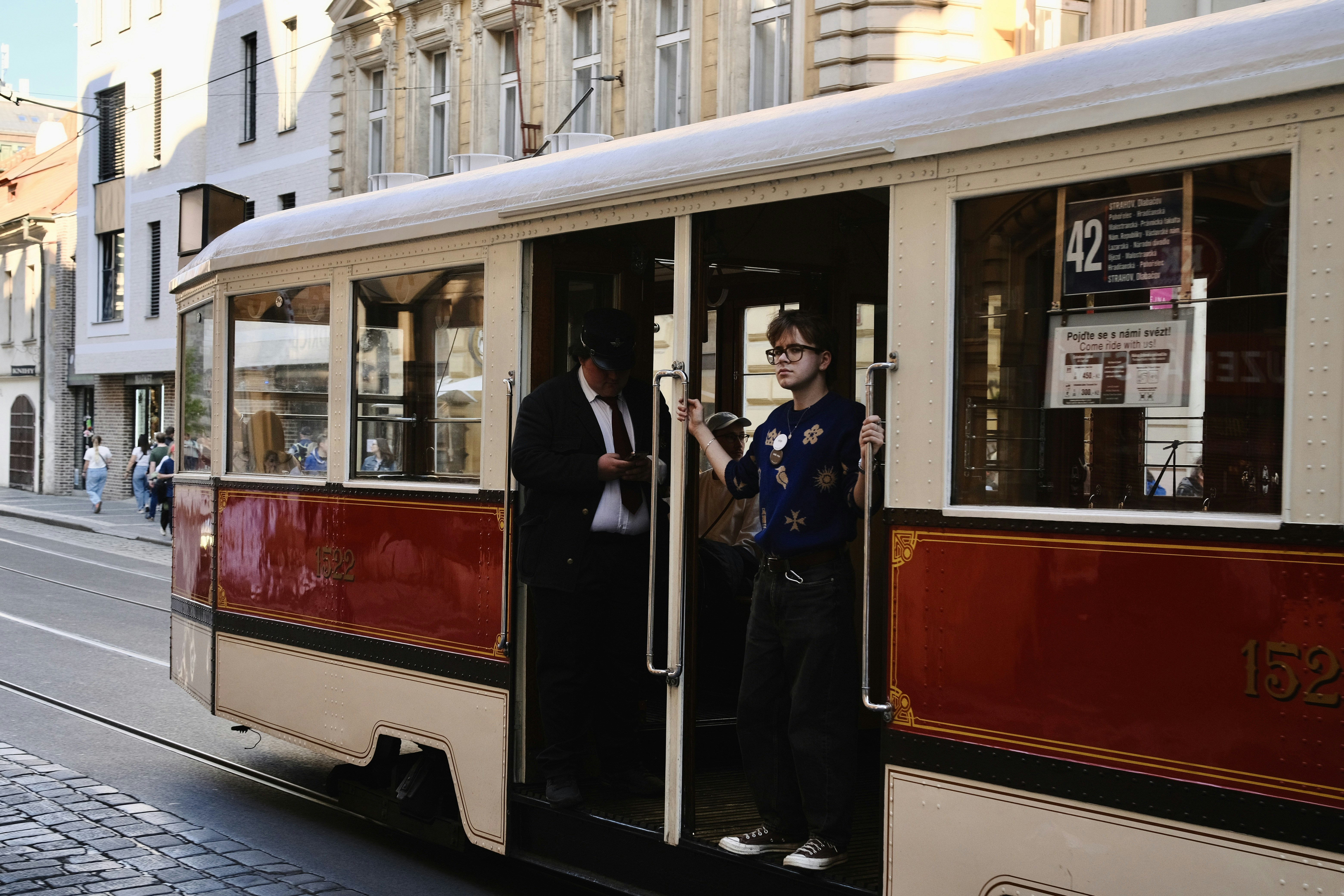Gentleman and Tourist Shake Hands from a Vintage Tram Door