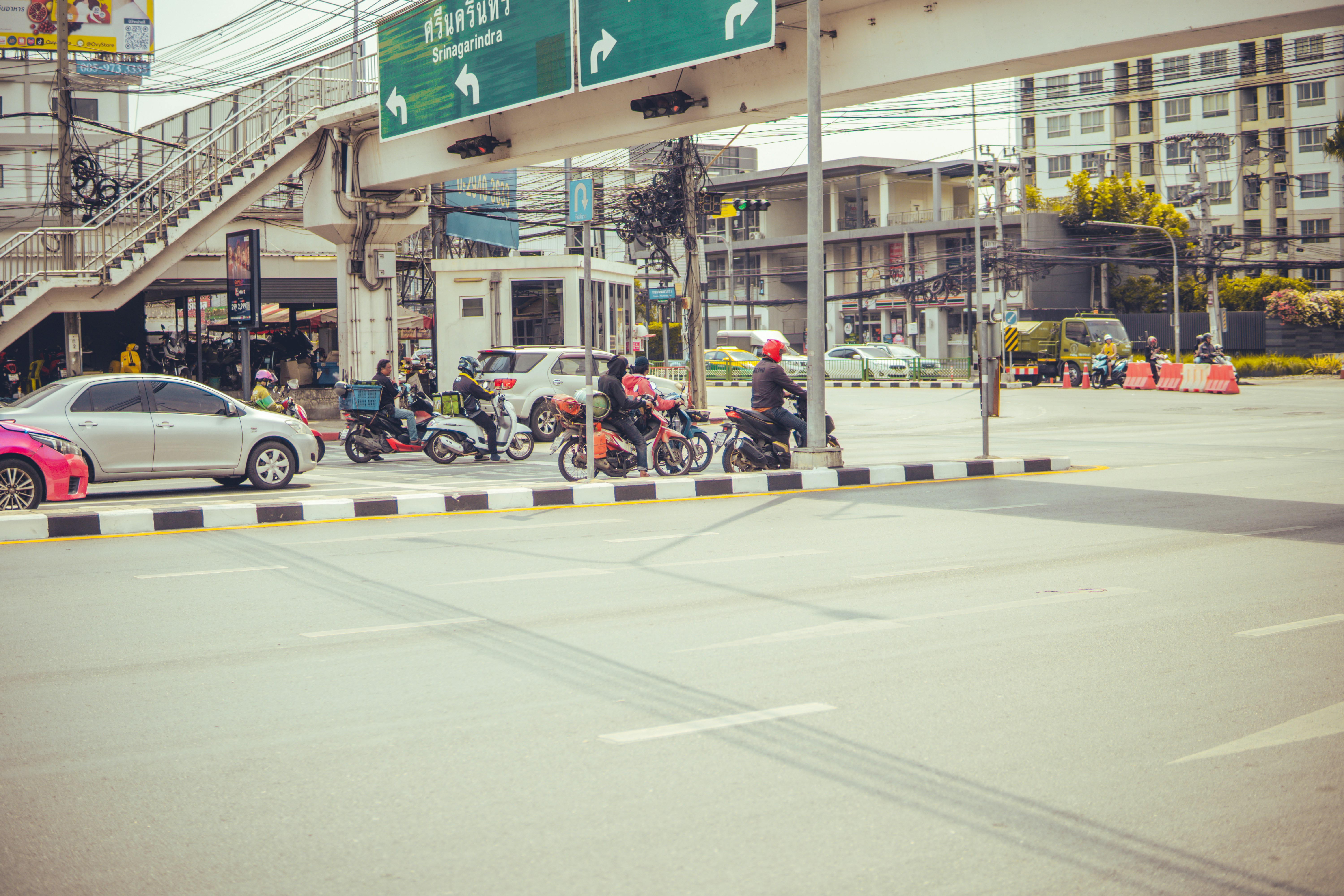 Overpass Corridor: City Traffic Beneath a Stoic Signboard