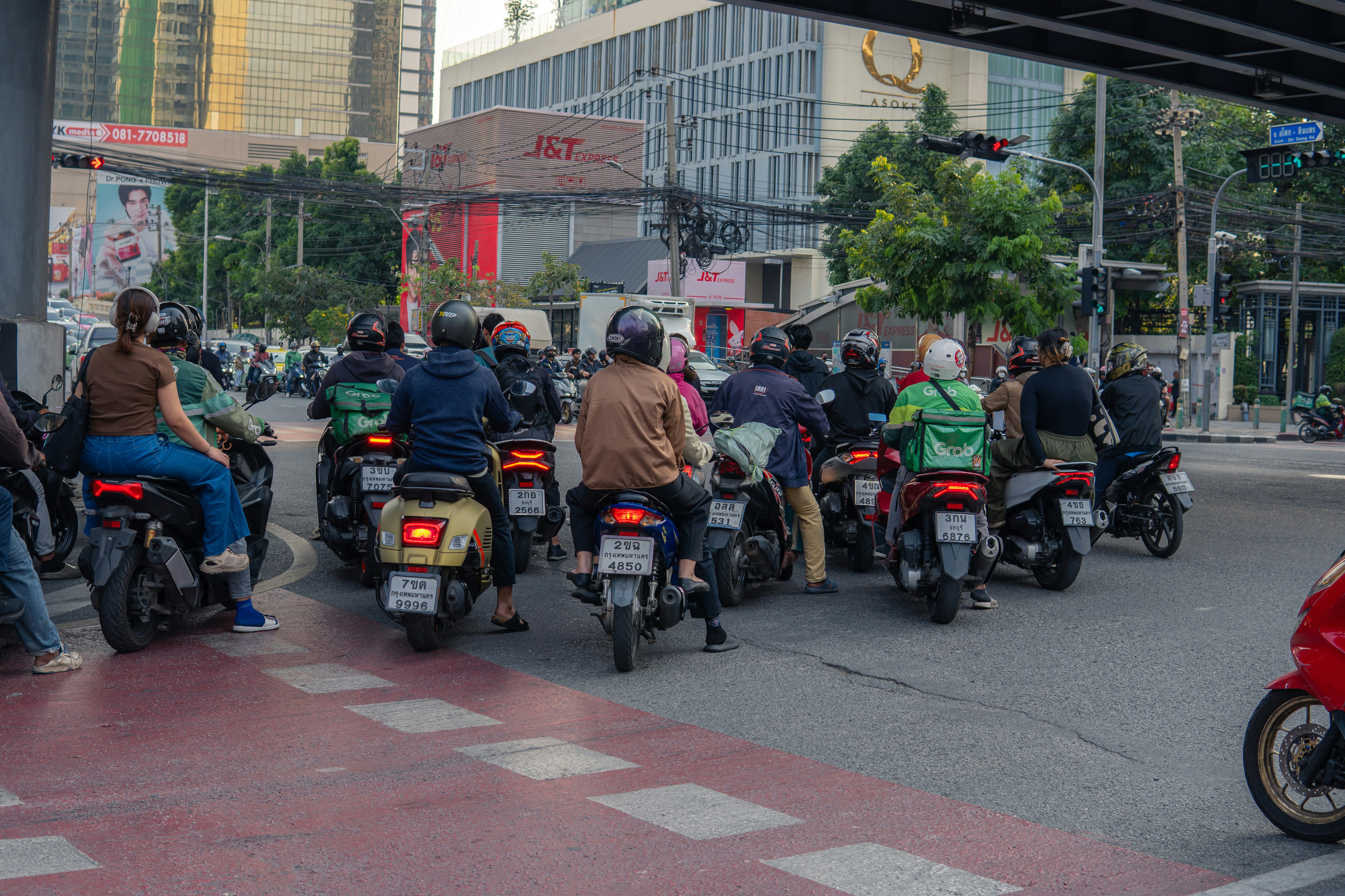 Line of Waiting Riders at a Busy Urban Intersection