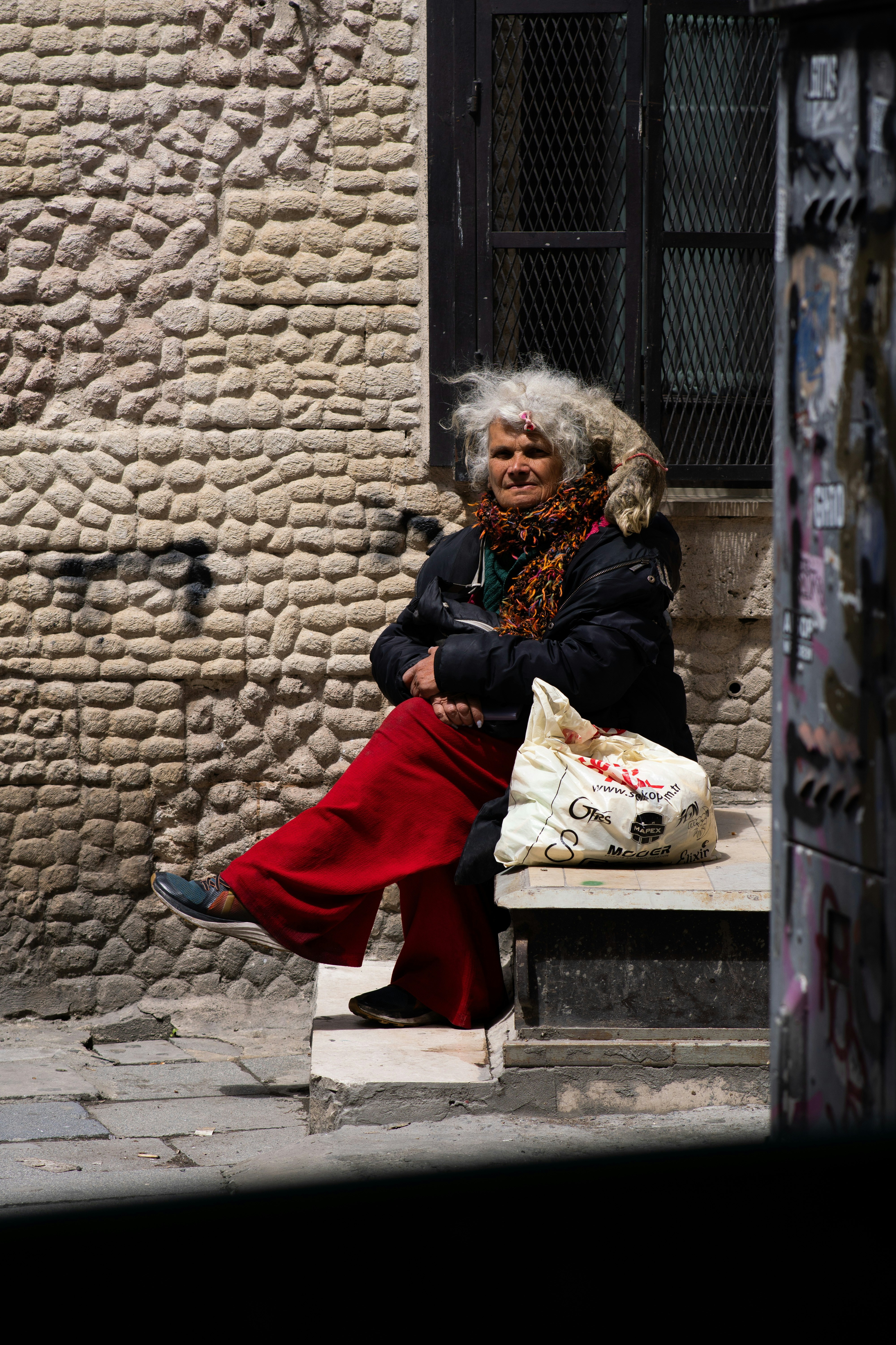 A Weathered Smile on a Cobblestone Corner