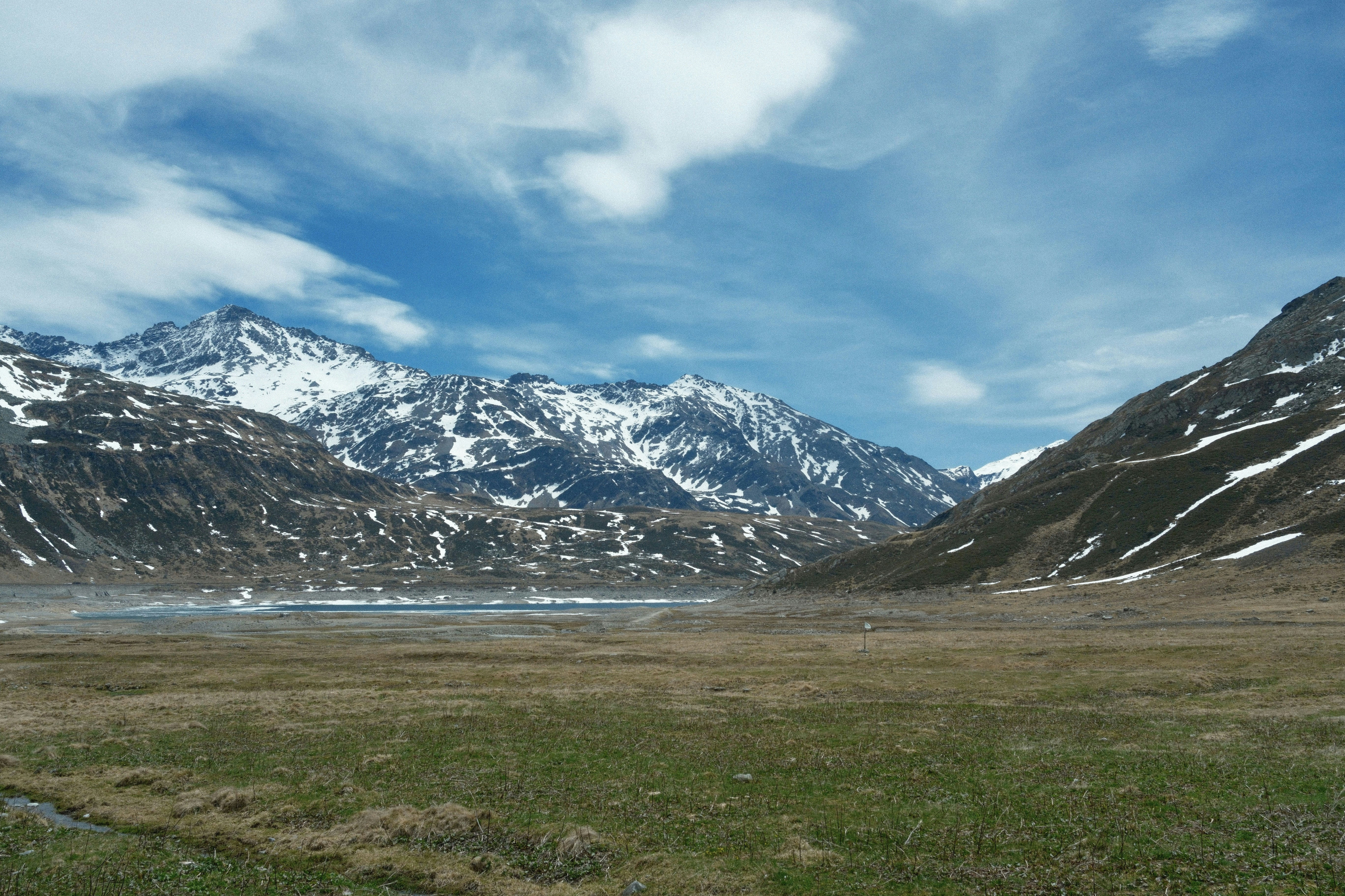 Snow-dusted Peaks Over a Quiet Alpine Plain