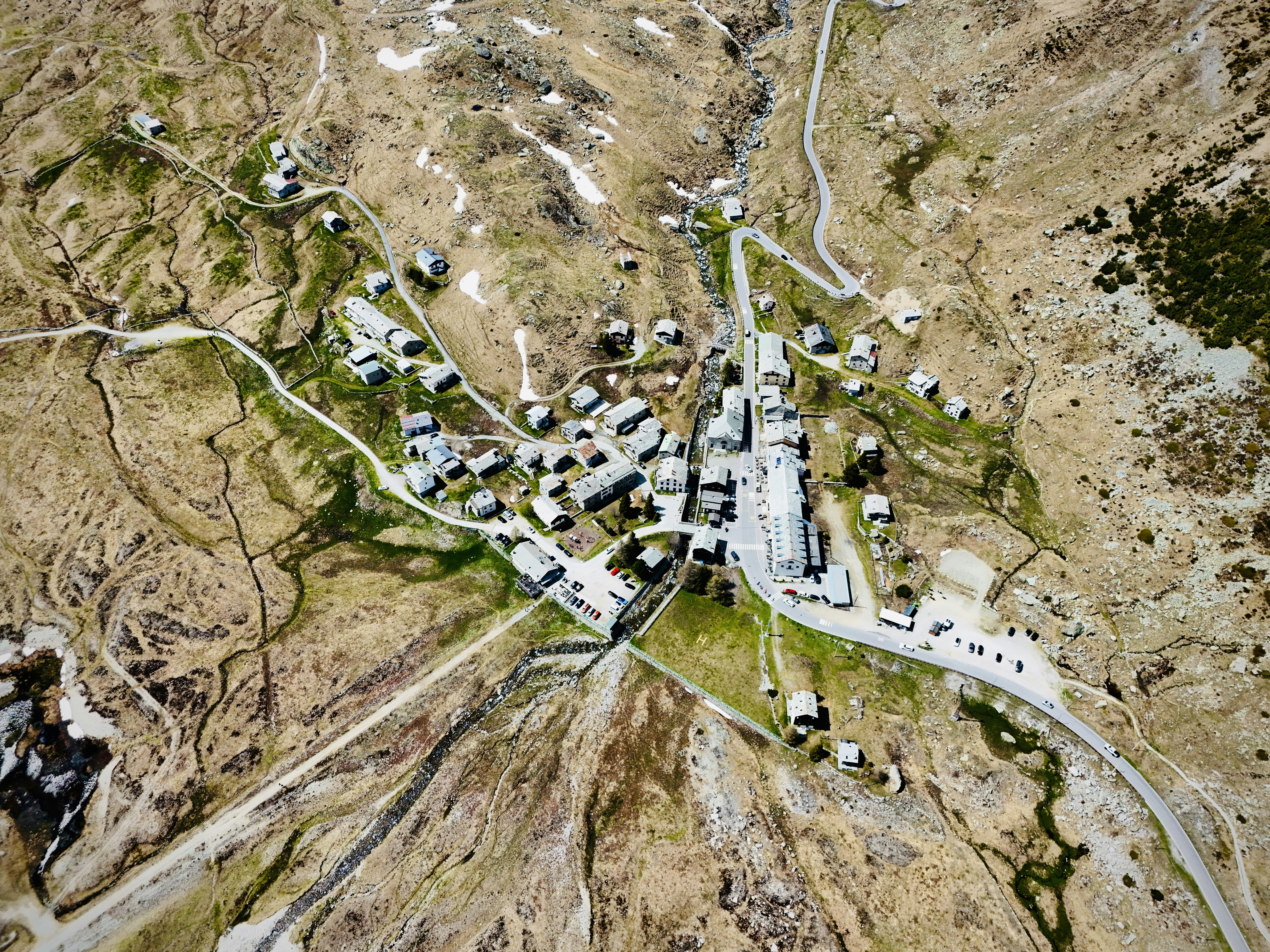 A hillside village cluster tucked along winding mountain roads