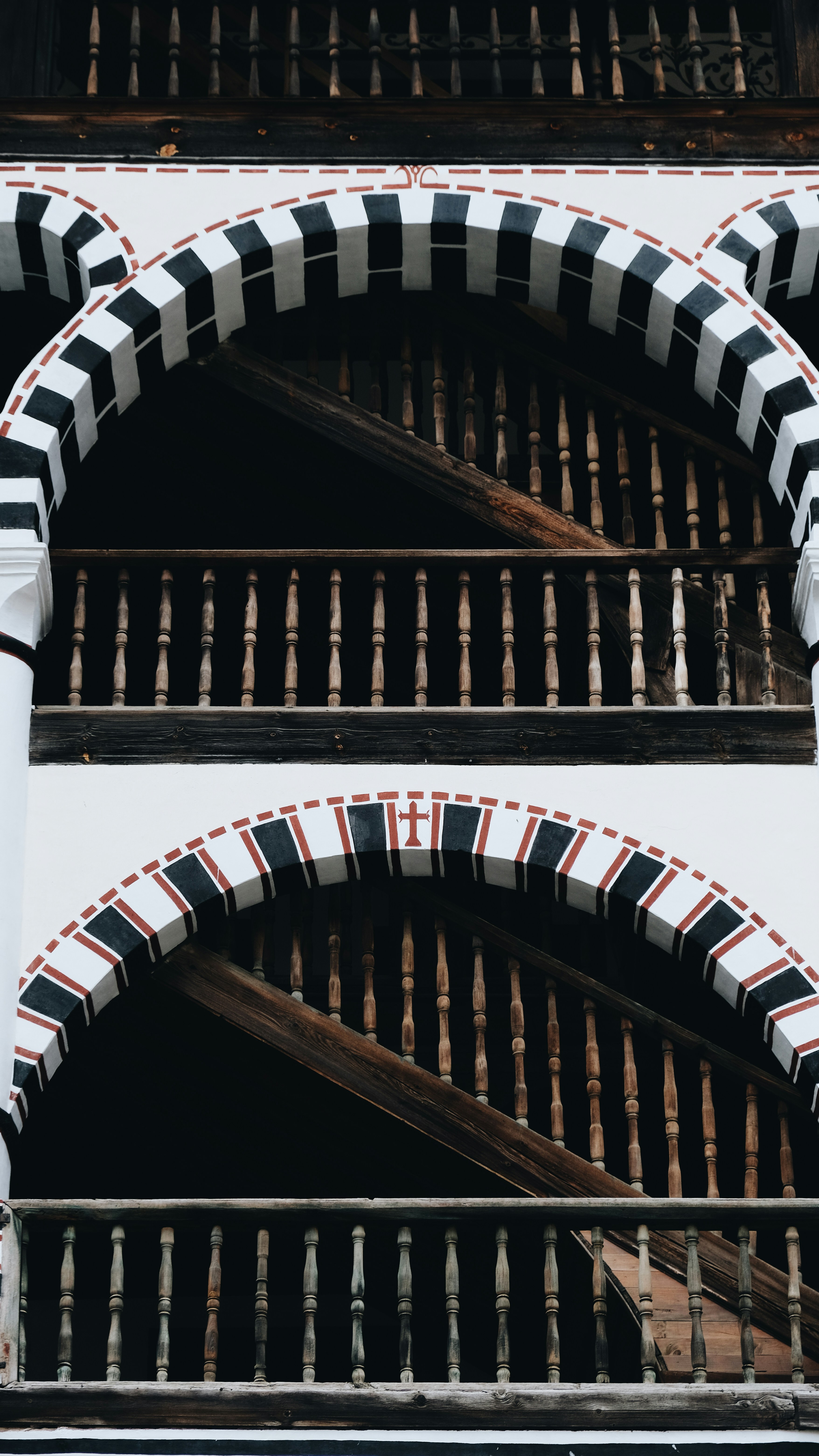 Geometric arches and carved balustrades: a facade of black-and-white rhythm