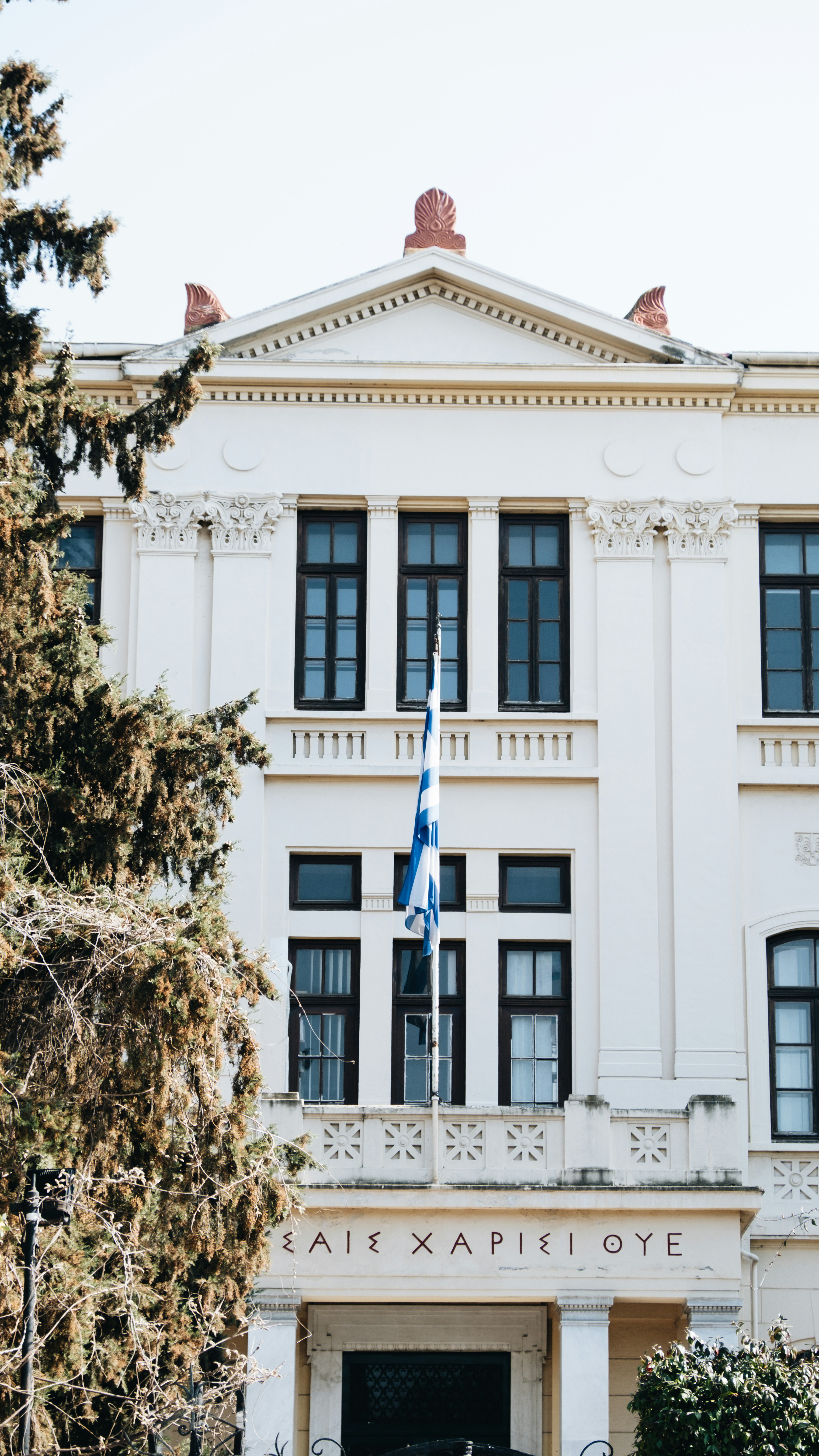 Greek Flag Over a Historic White Facade