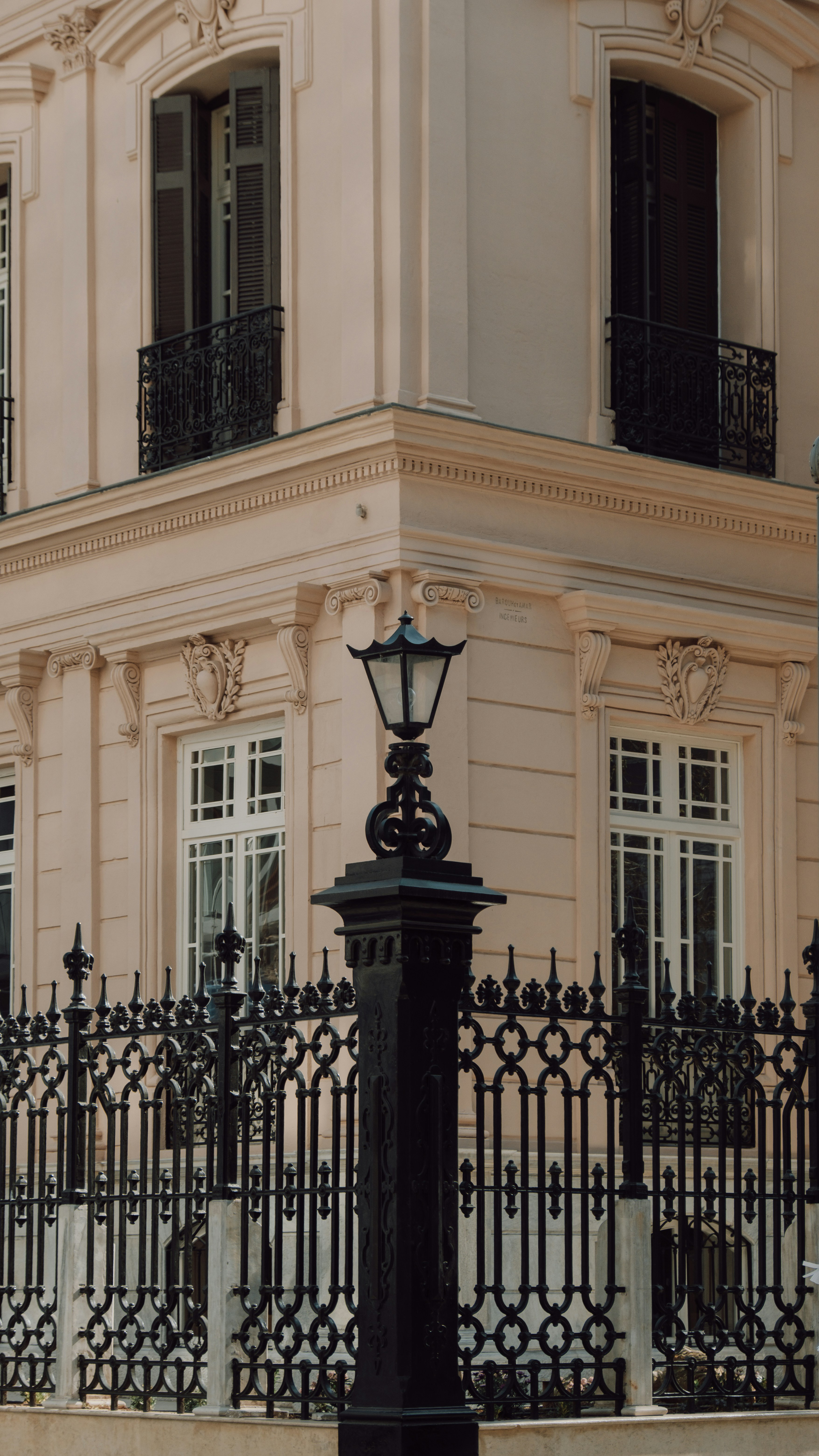 Ornate Corner of a Parisian-Style Facade Framed by Wrought-Iron Veil