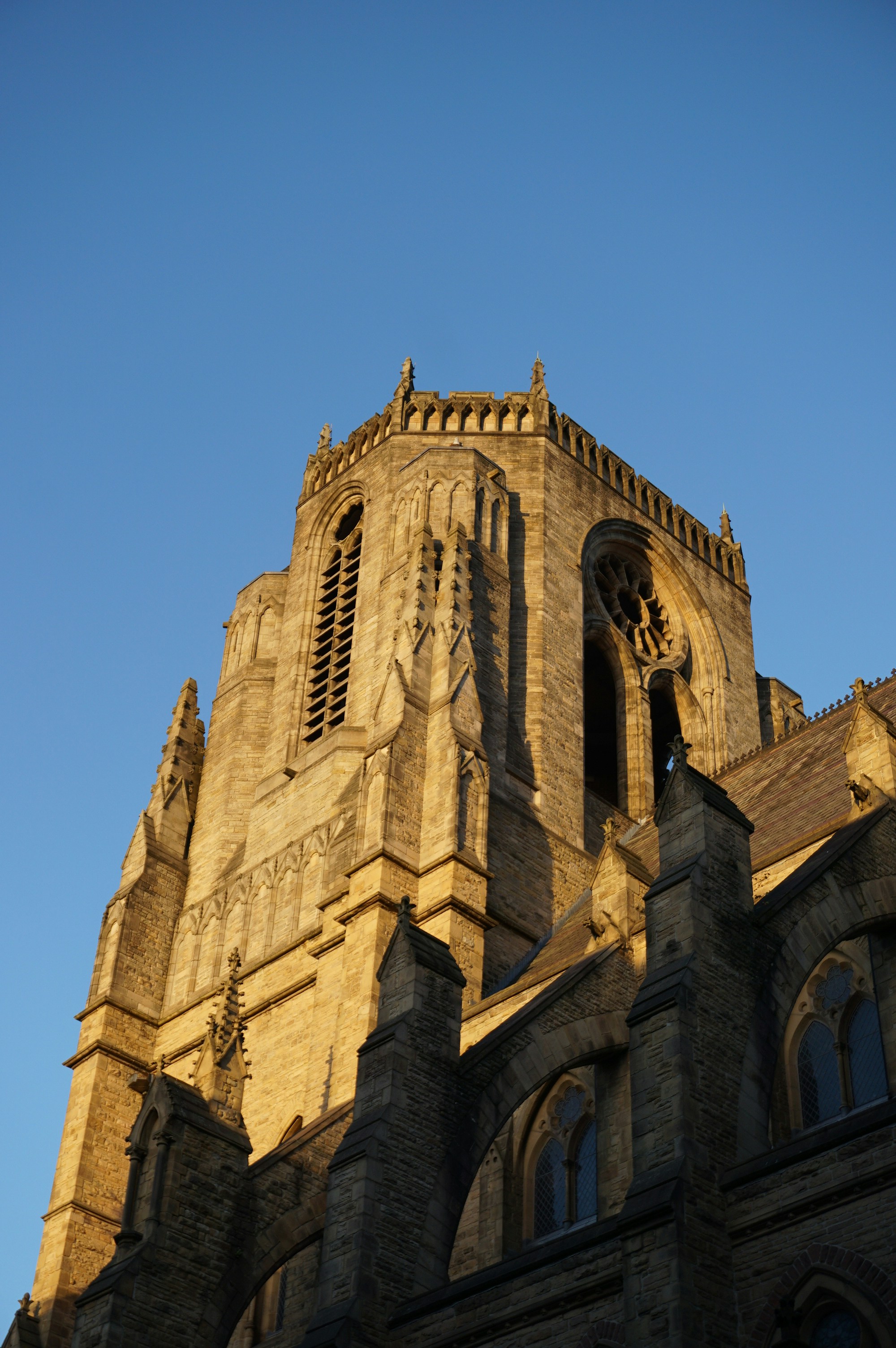 Sunlit Spires: A Gothic Cathedral Reaches Toward a Clear Evening Sky