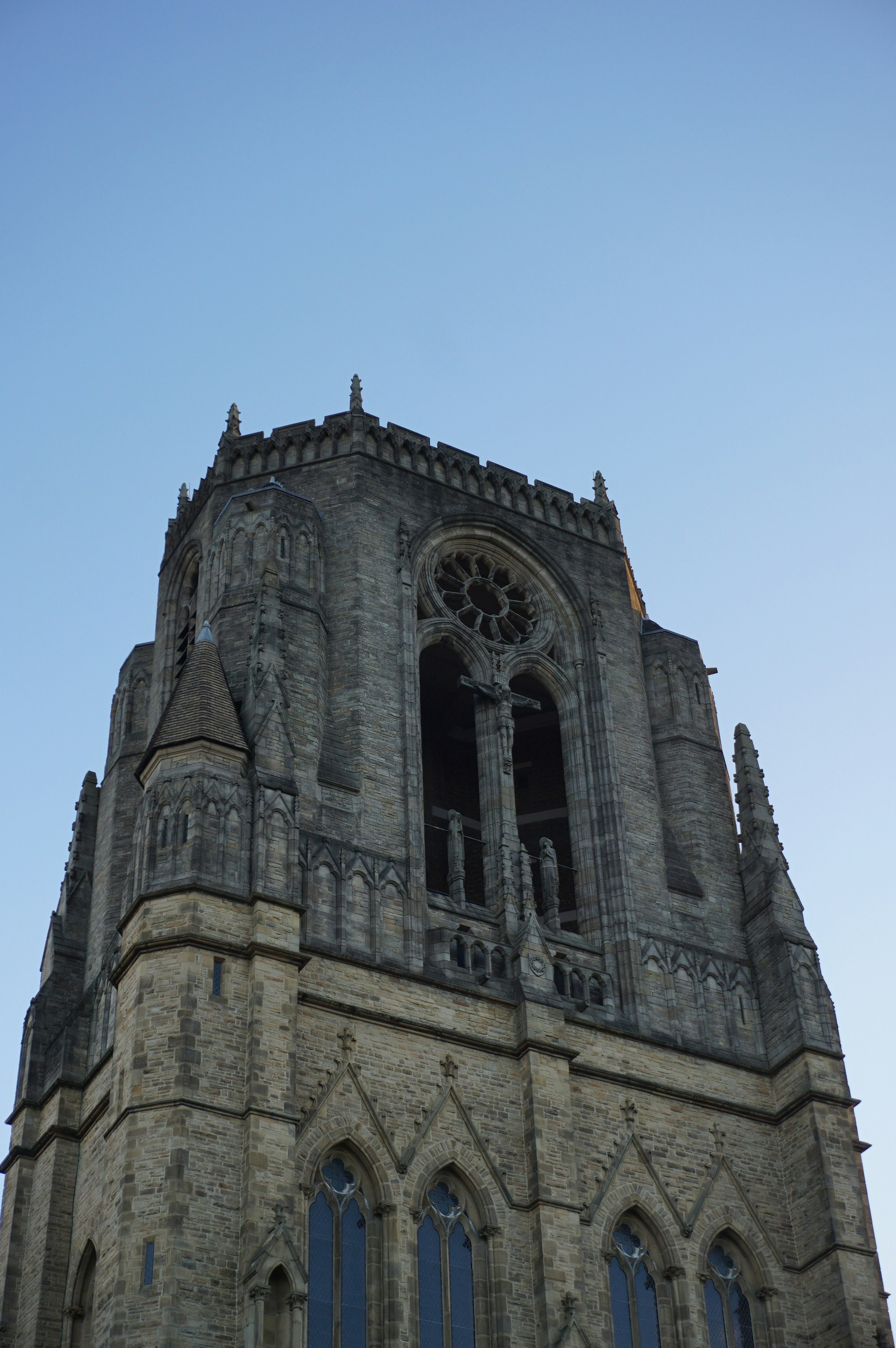 Gothic Facade Reaching Toward a Clear Gradient Sky
