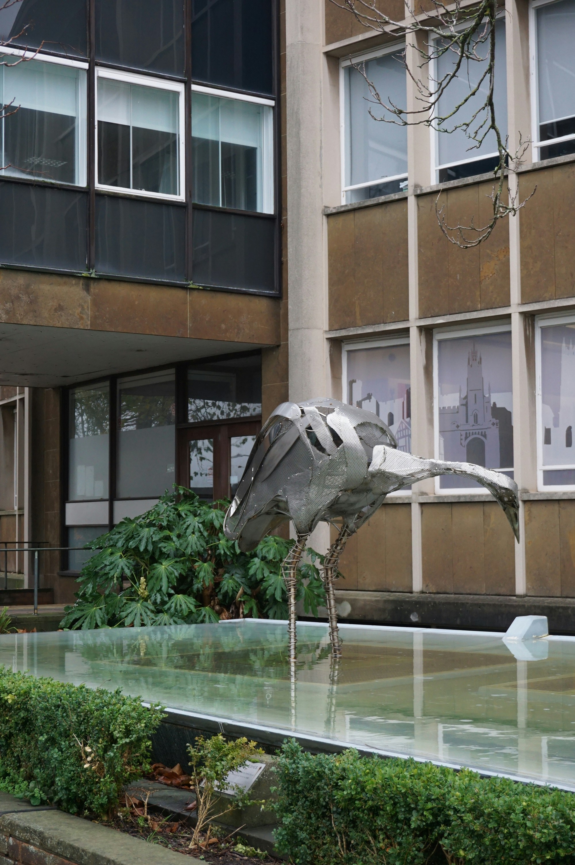 Skeletal Heron: A Metal Swan Emerges Over a Tranquil Basin