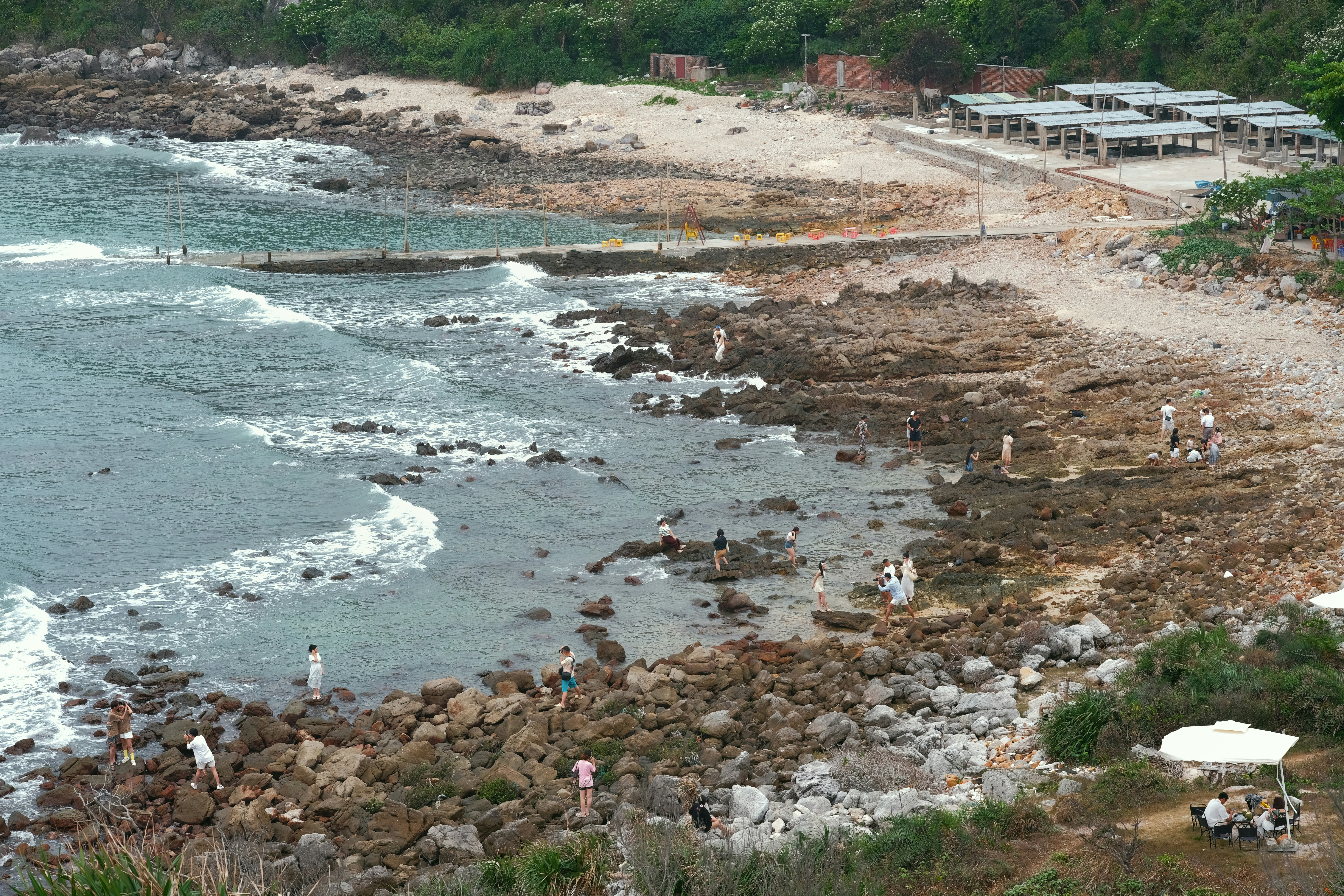 Rocky shoreline Tides and People at a Winding Beach