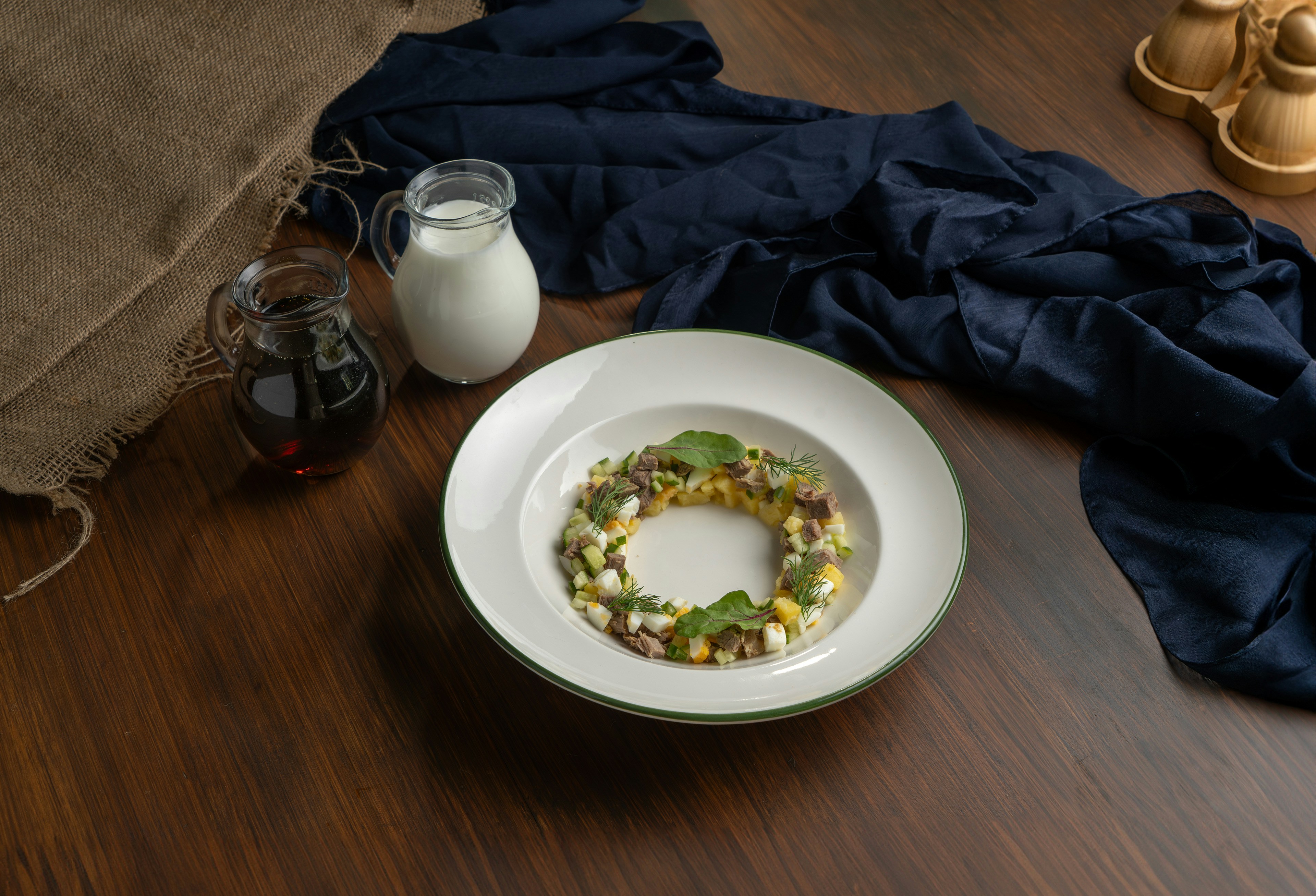 Circular Harvest: a plated ring of colorful ingredients on a dark wooden table