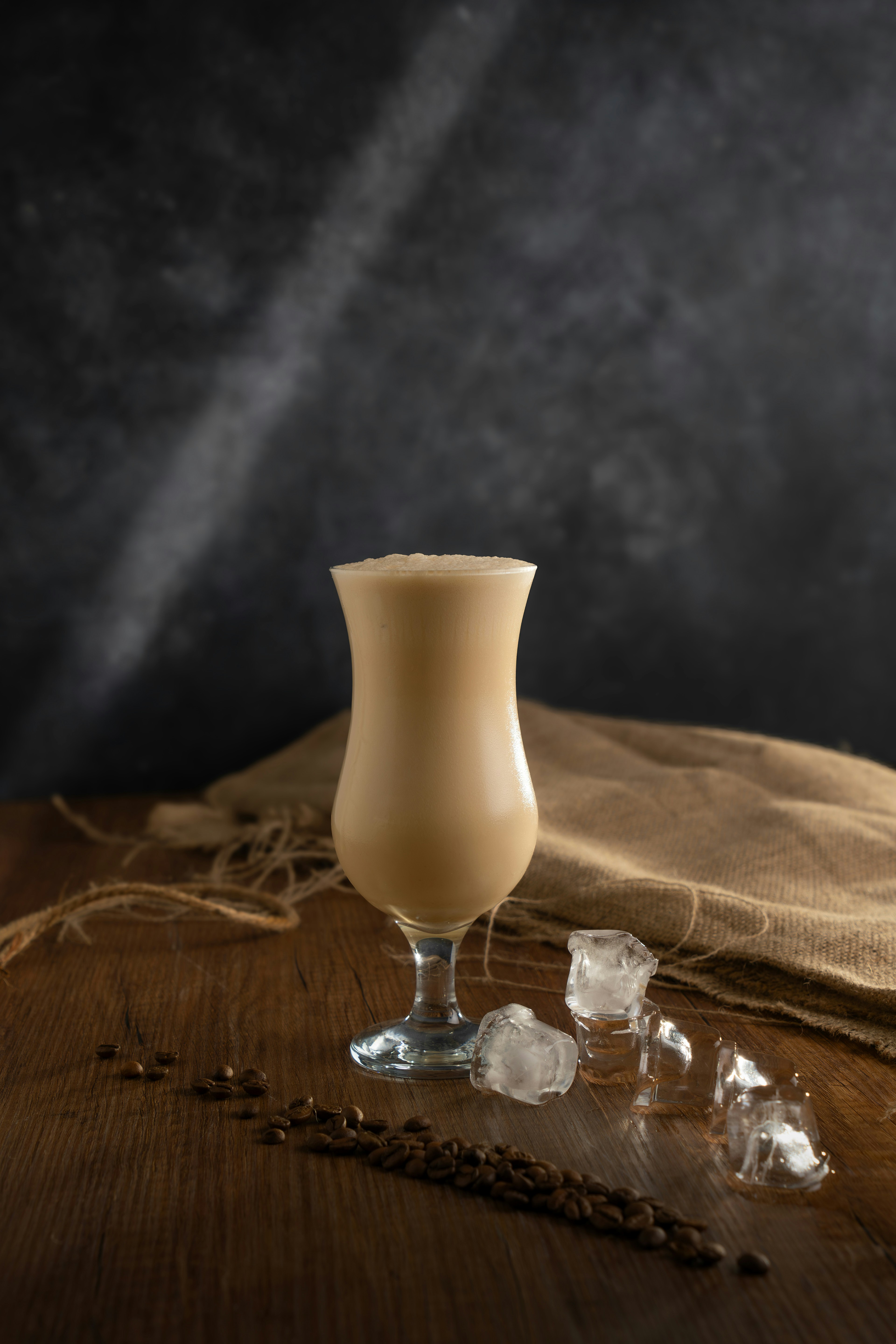 Creamy Horizon: A Topped Glass on a Rustic Table