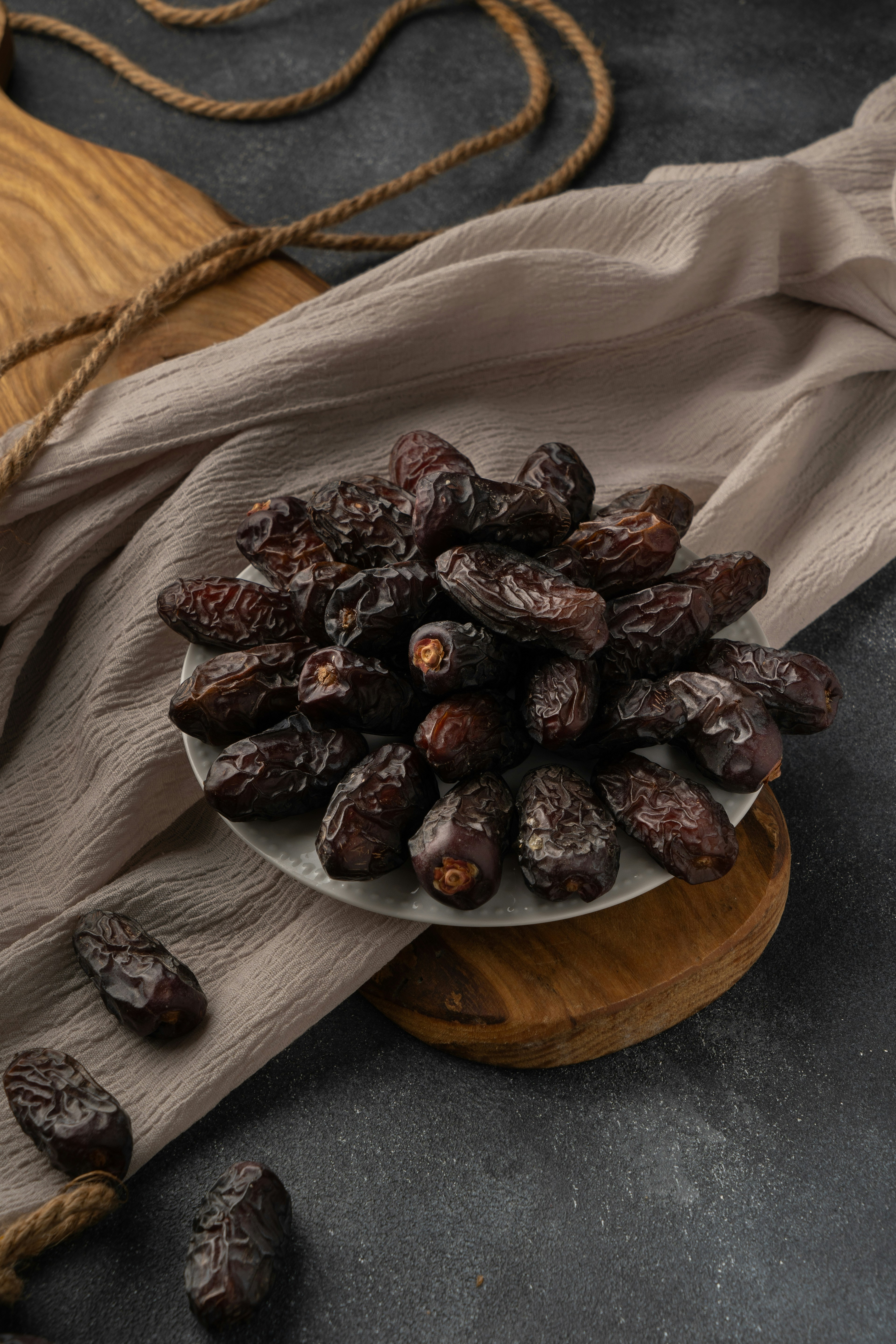 Plate of glossy dates on a textured backdrop