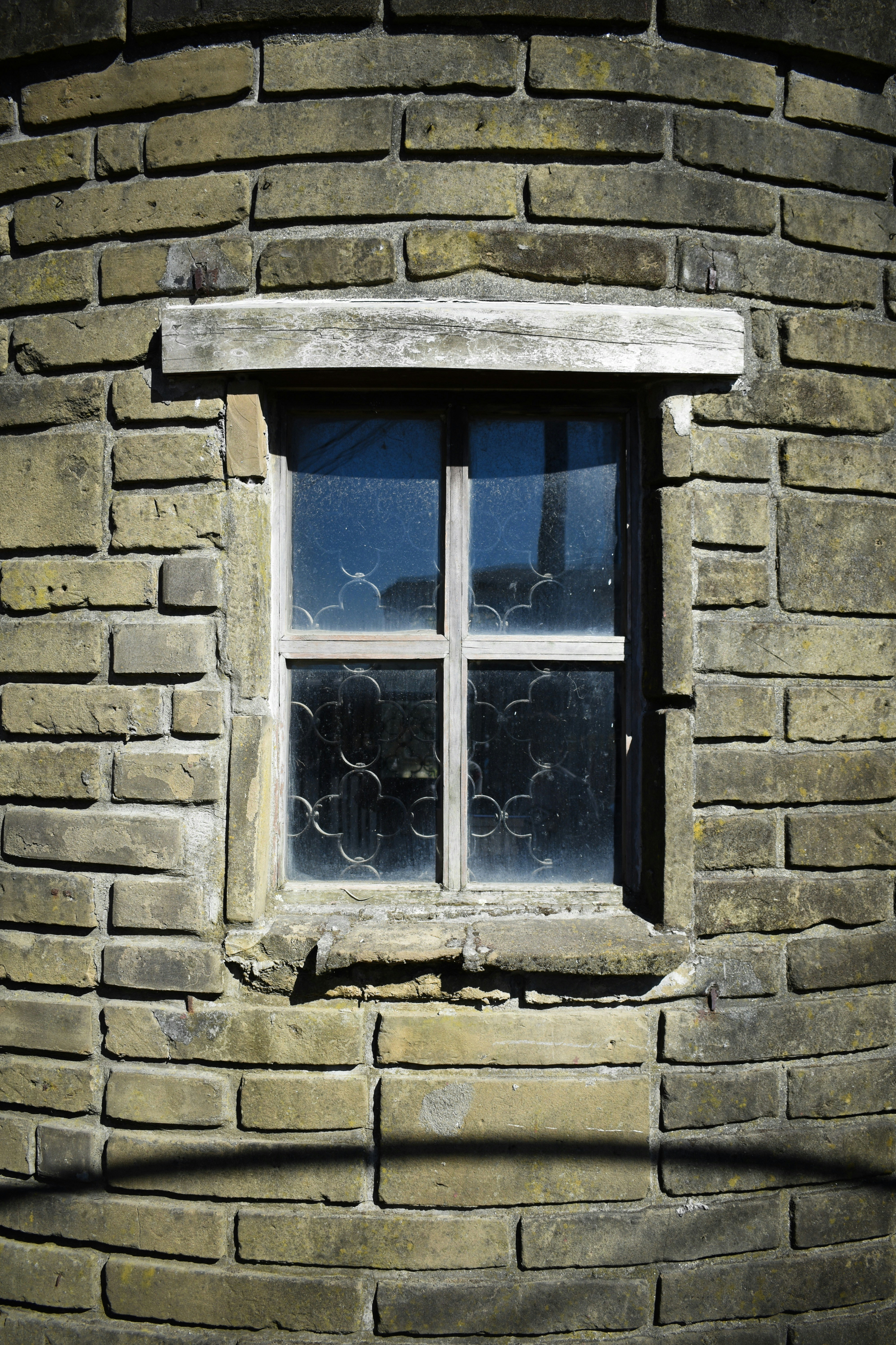 Weathered Window in a Stone Wall: Quiet Geometry and Timeworn Light