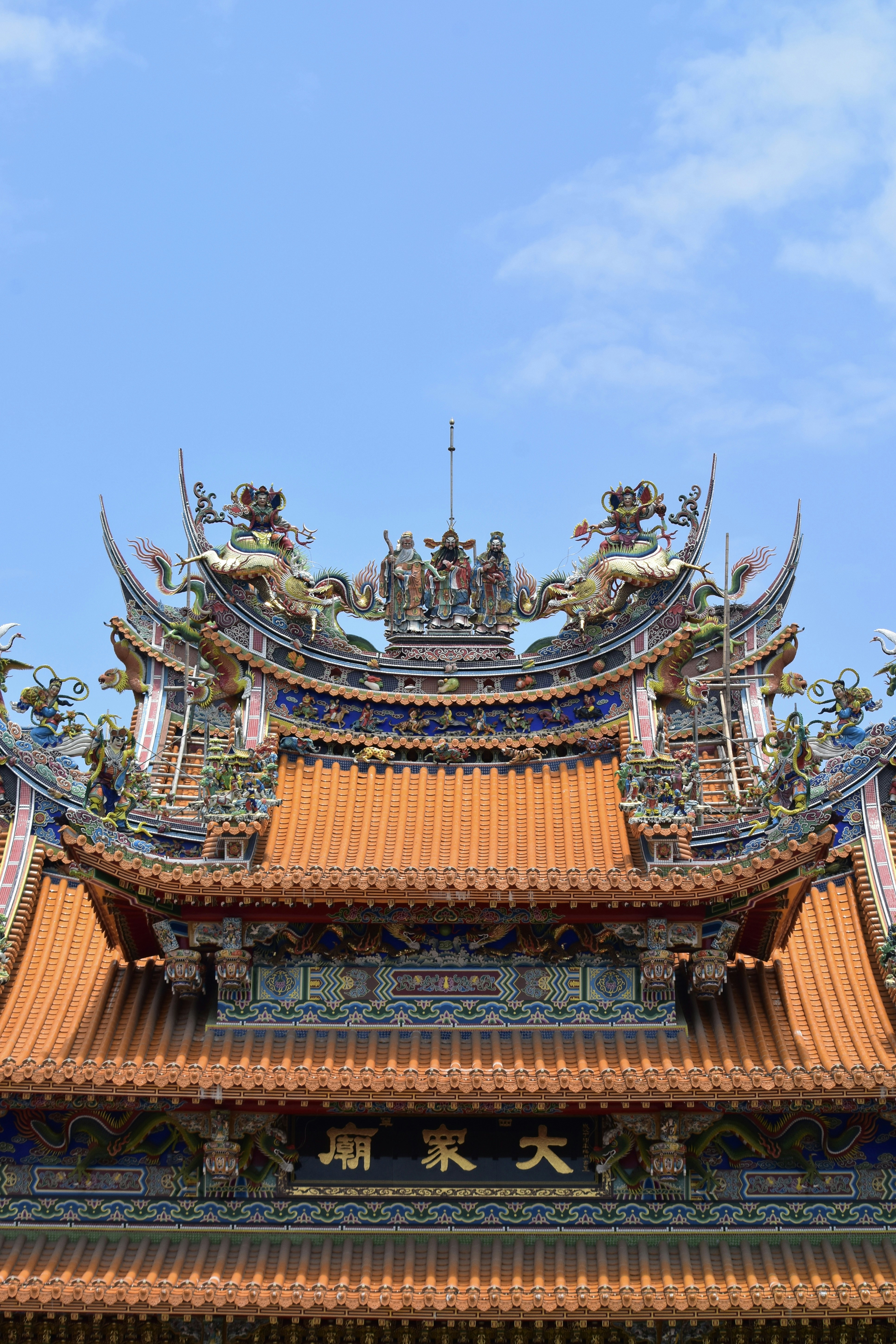 Temple Roof Ornaments Rise Above a Golden Terrace