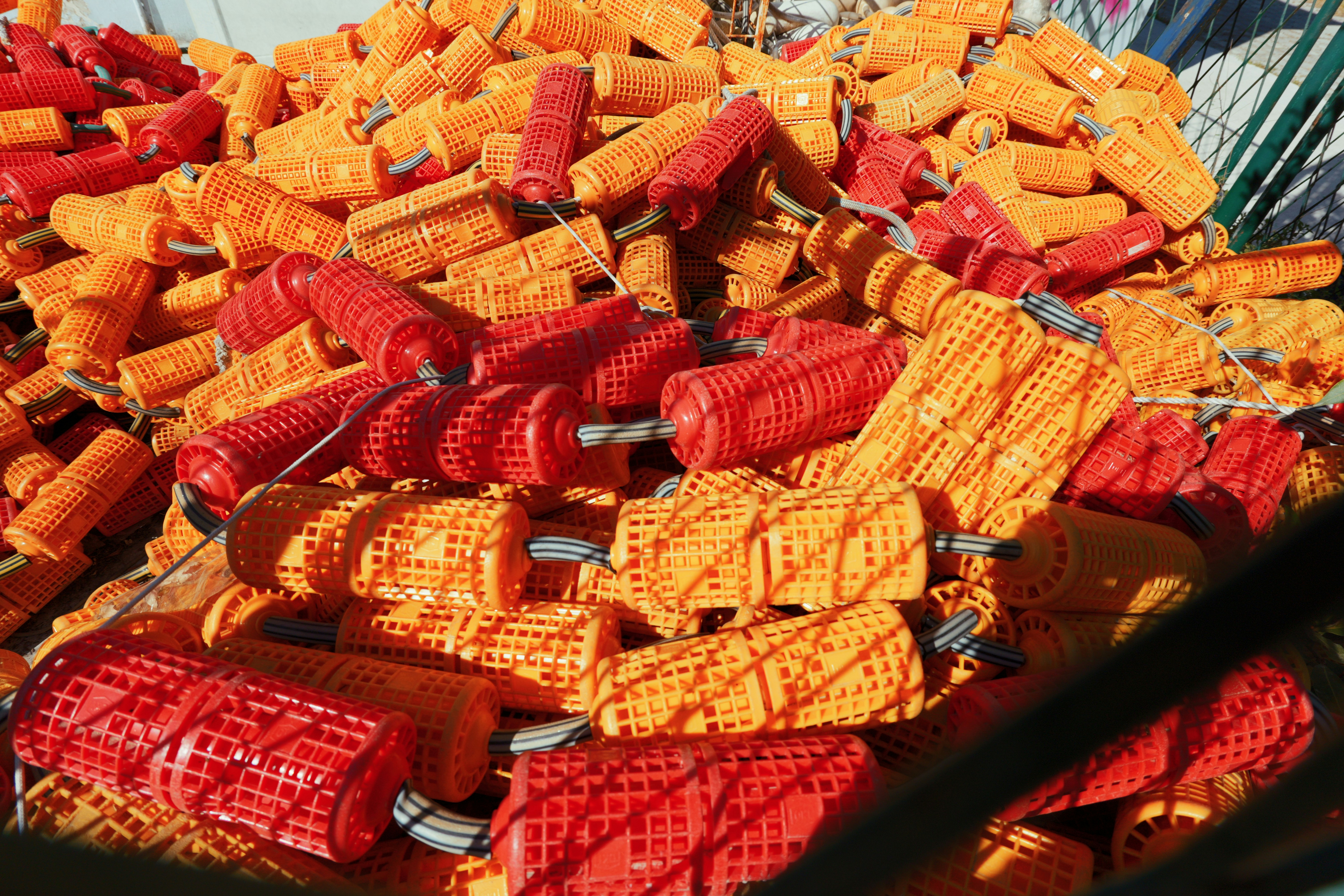 Cascade of Orange and Red Knit Grips: A Textured Tangle of Utility