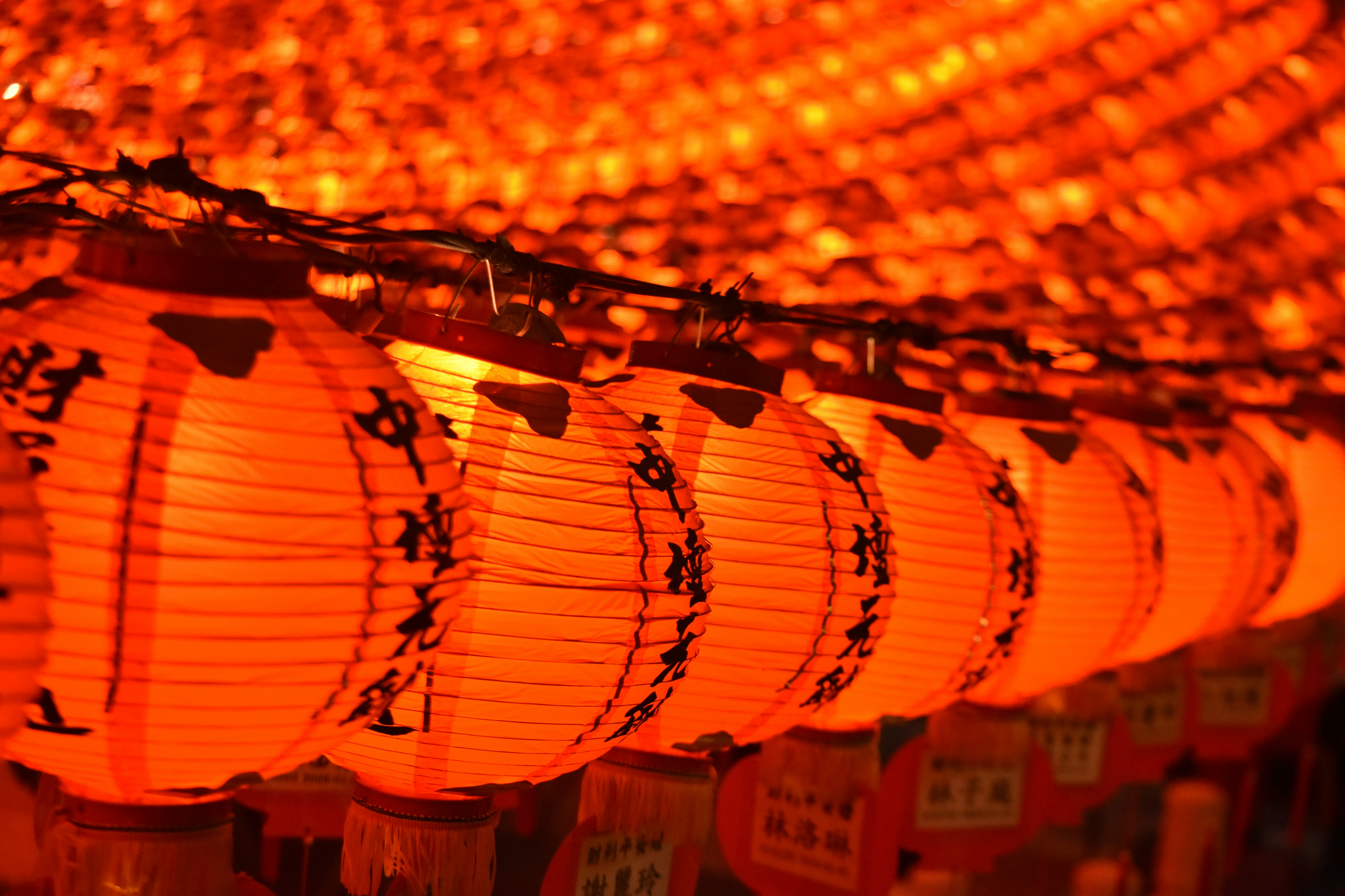 Lantern Row of Warmth: Red Passages Under Orange Glow