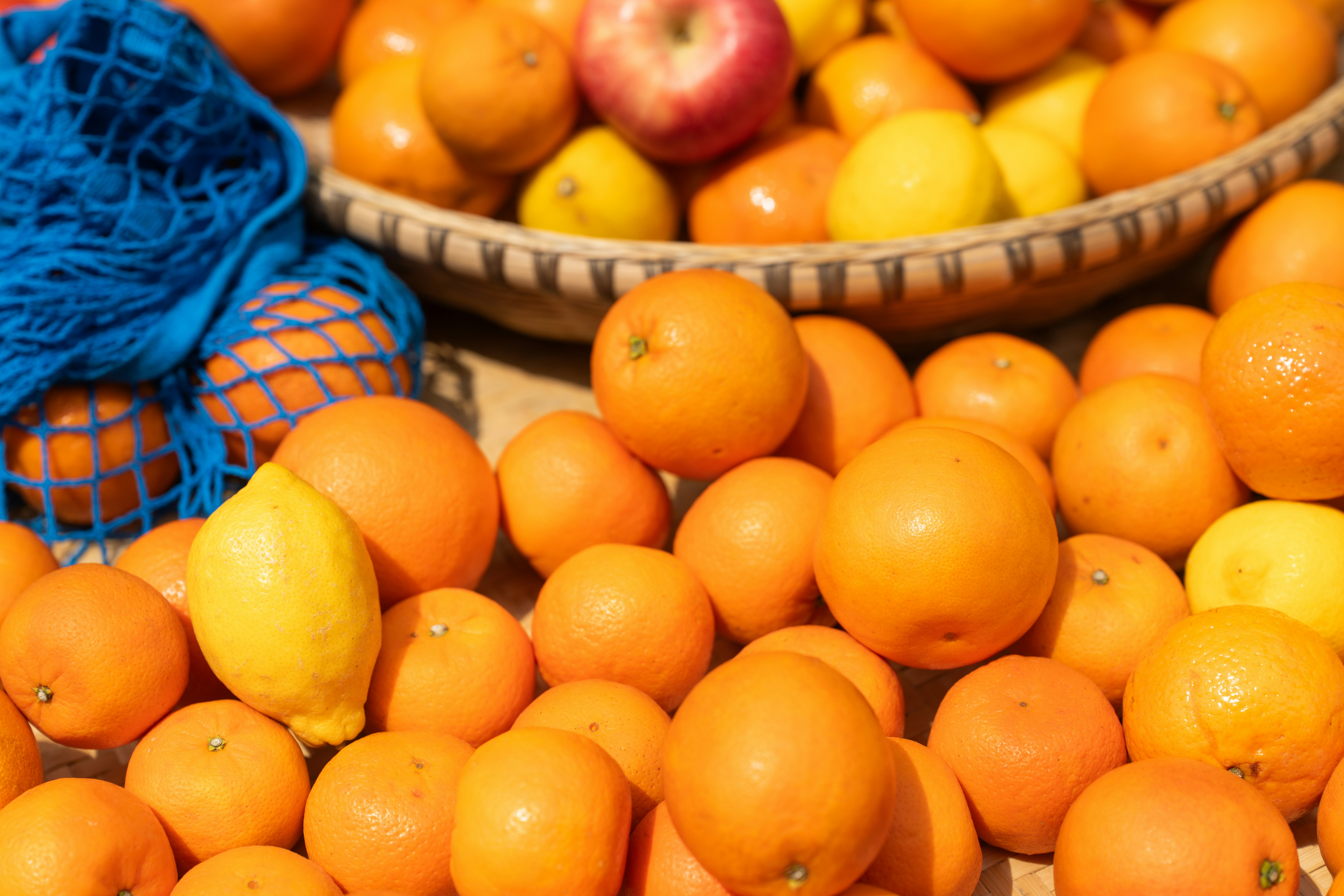 Sun-warmed Oranges spilling from a market basket