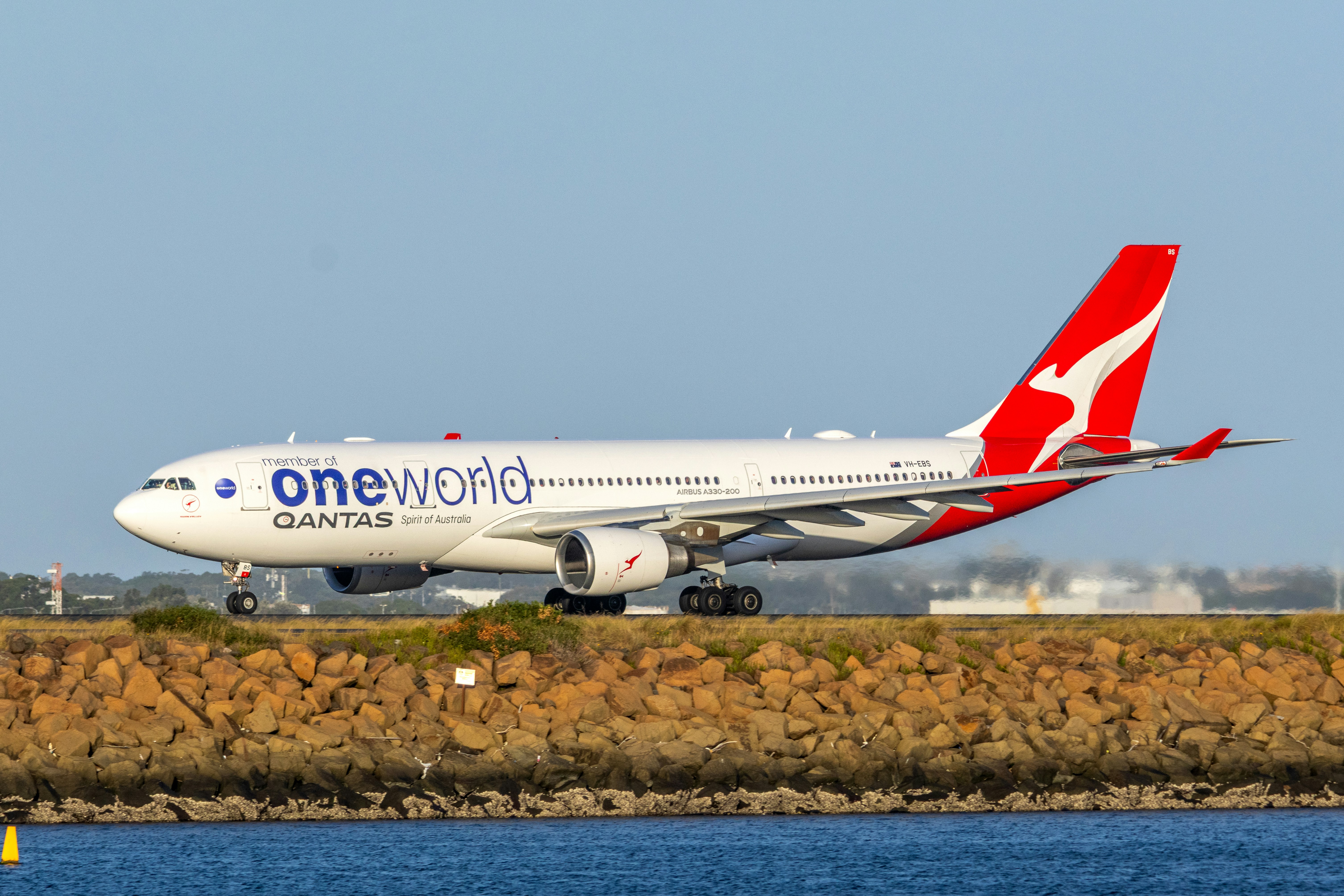 OneWorld on the Breakwater: Qantas A330 Rolling Past the Jetty
