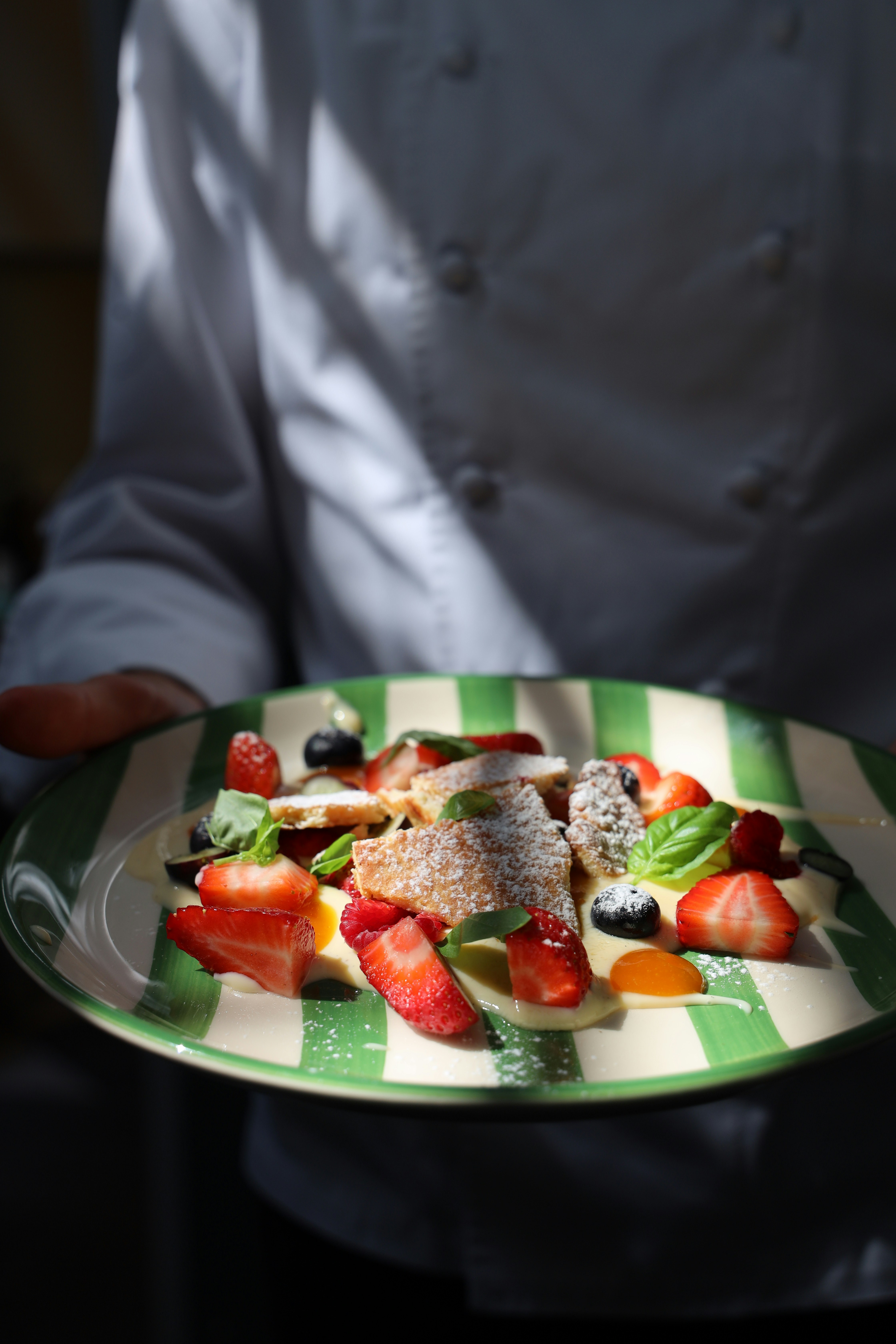 Dessert on a Striped Green Plate: Strawberry Varietals and Powdered Sugar