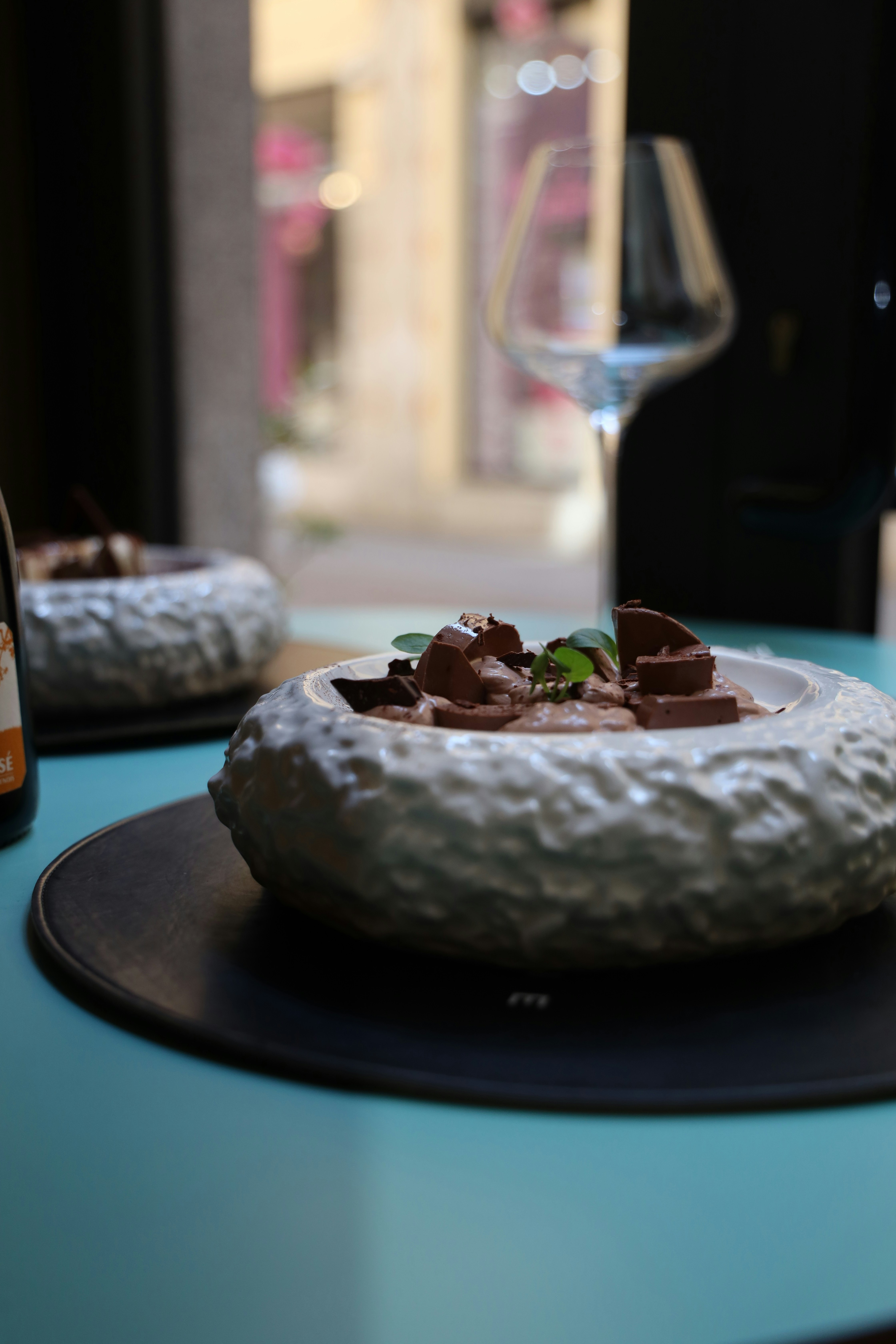 A Round Chocolate Mosaic on a Turquoise Table