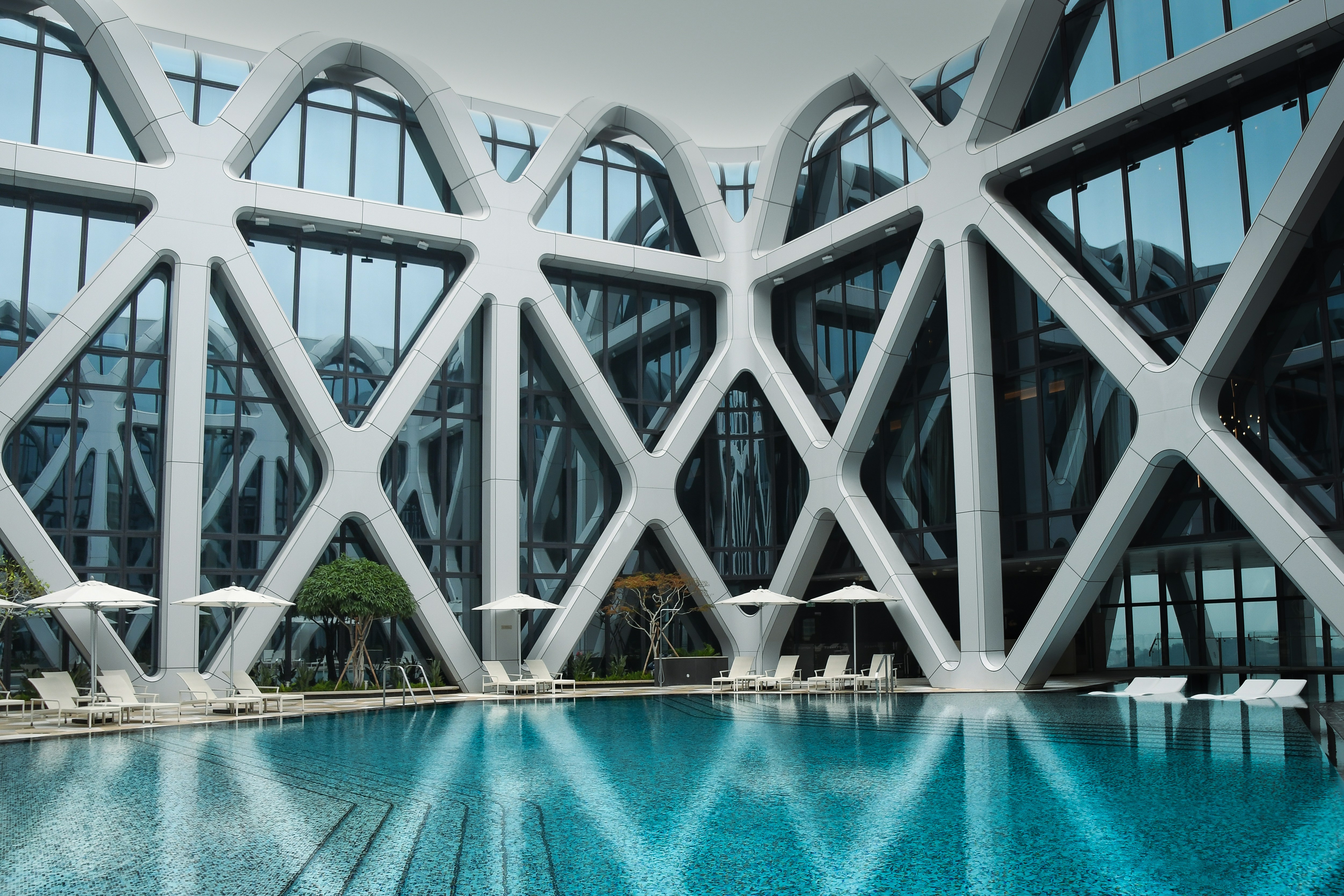 Geometric Glass Facade Overlooking a Tranquil Pool