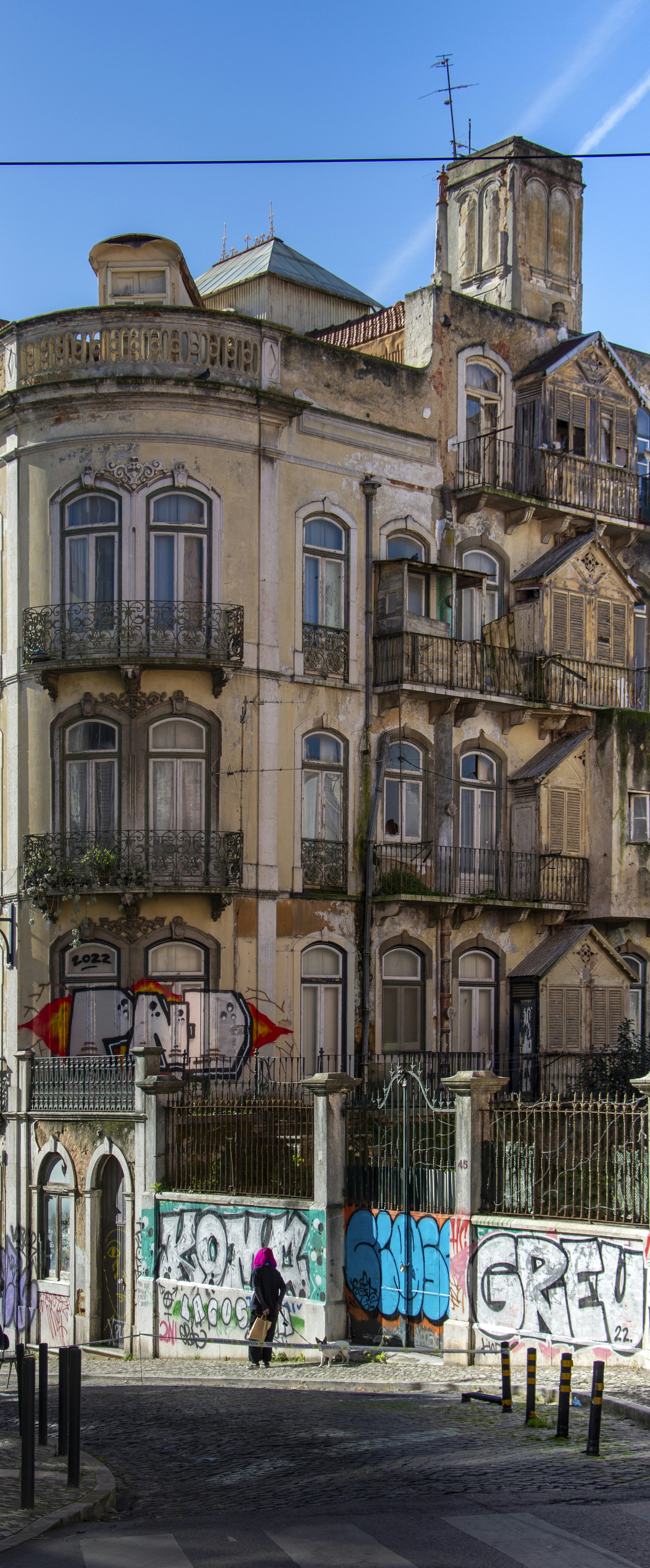 Weathered Facade, Graffiti Gate: A Corner of Urban Decay