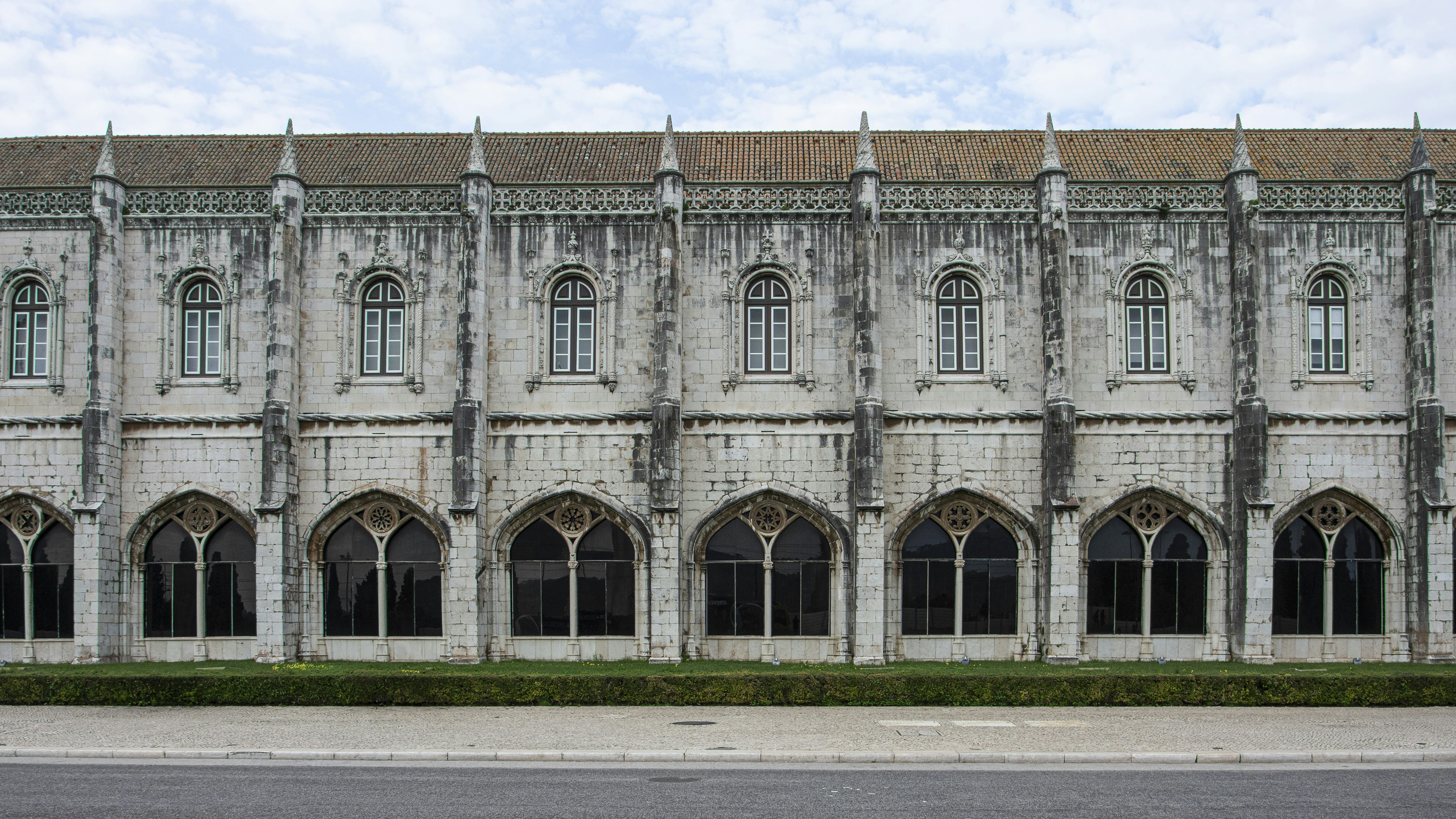 Symmetry in Stone: A Premier Facade of Arched Windows and Colonnades