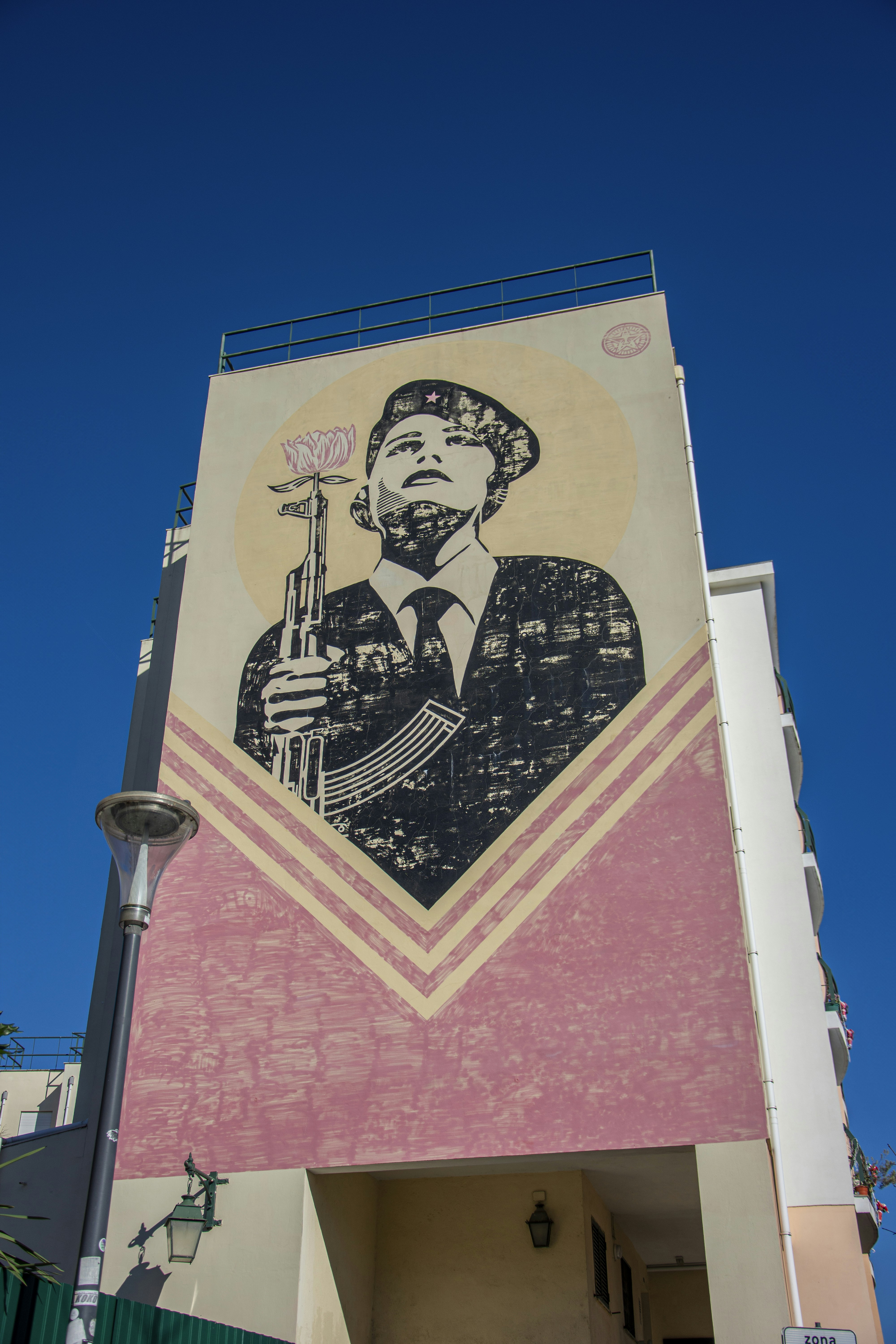 Concrete Hero: A Bold Mural Reaching Toward the Sky