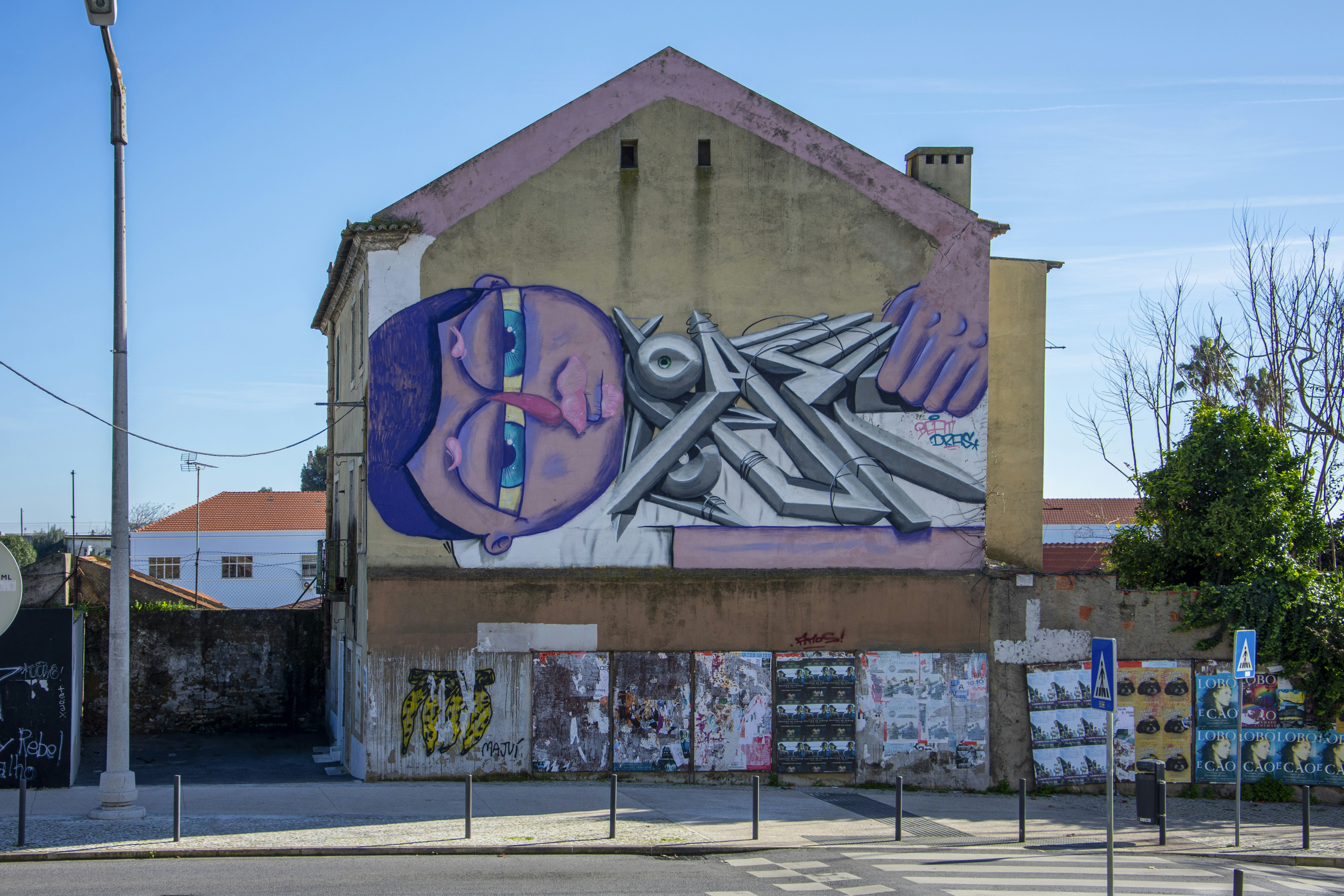 Giant Graffiti Portrait Framing a Steel-Driven Dream on a Sunlit Facade