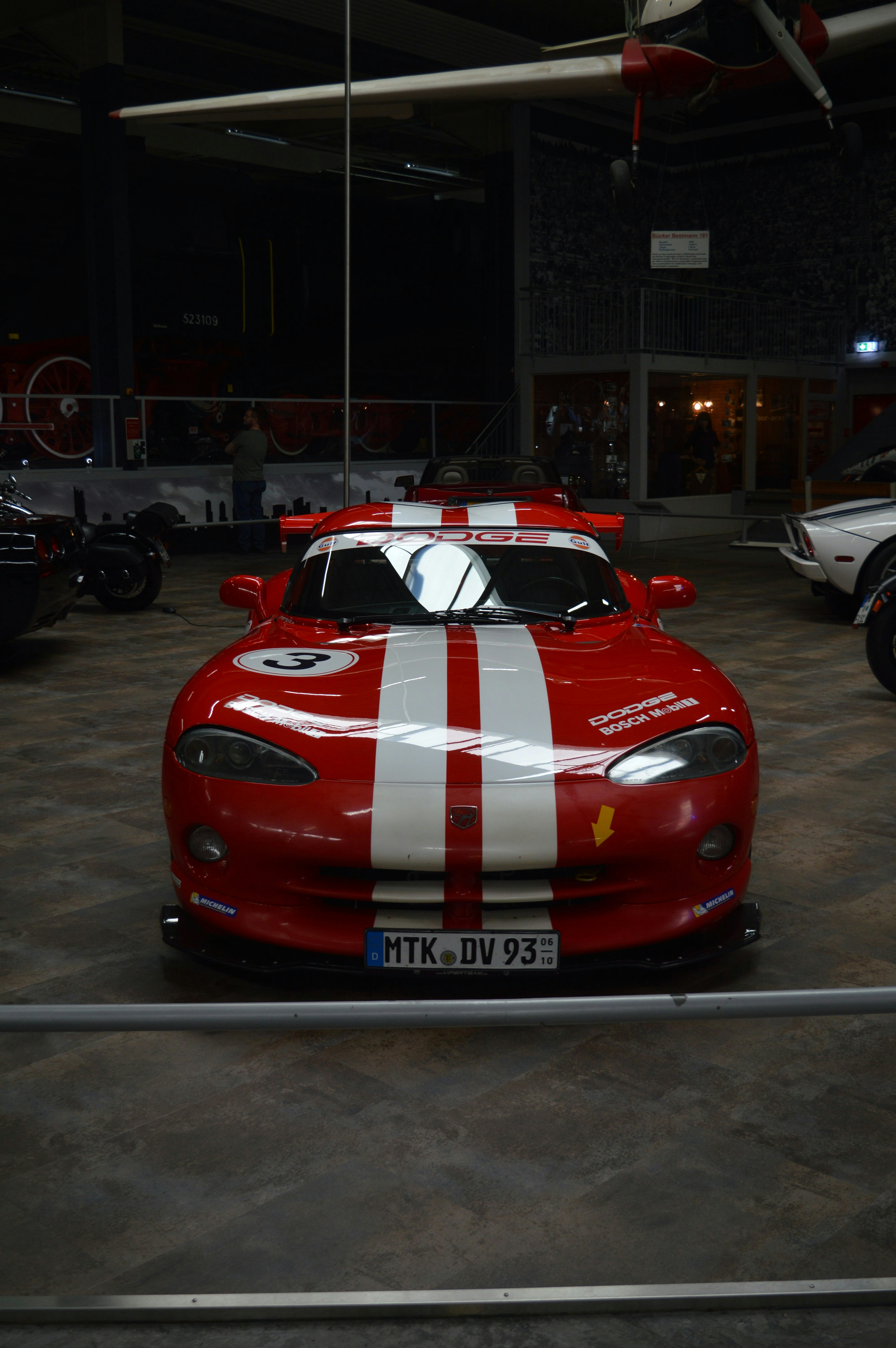 Red racing heritage: front view of a classic Dodge Viper in a dim museum hall