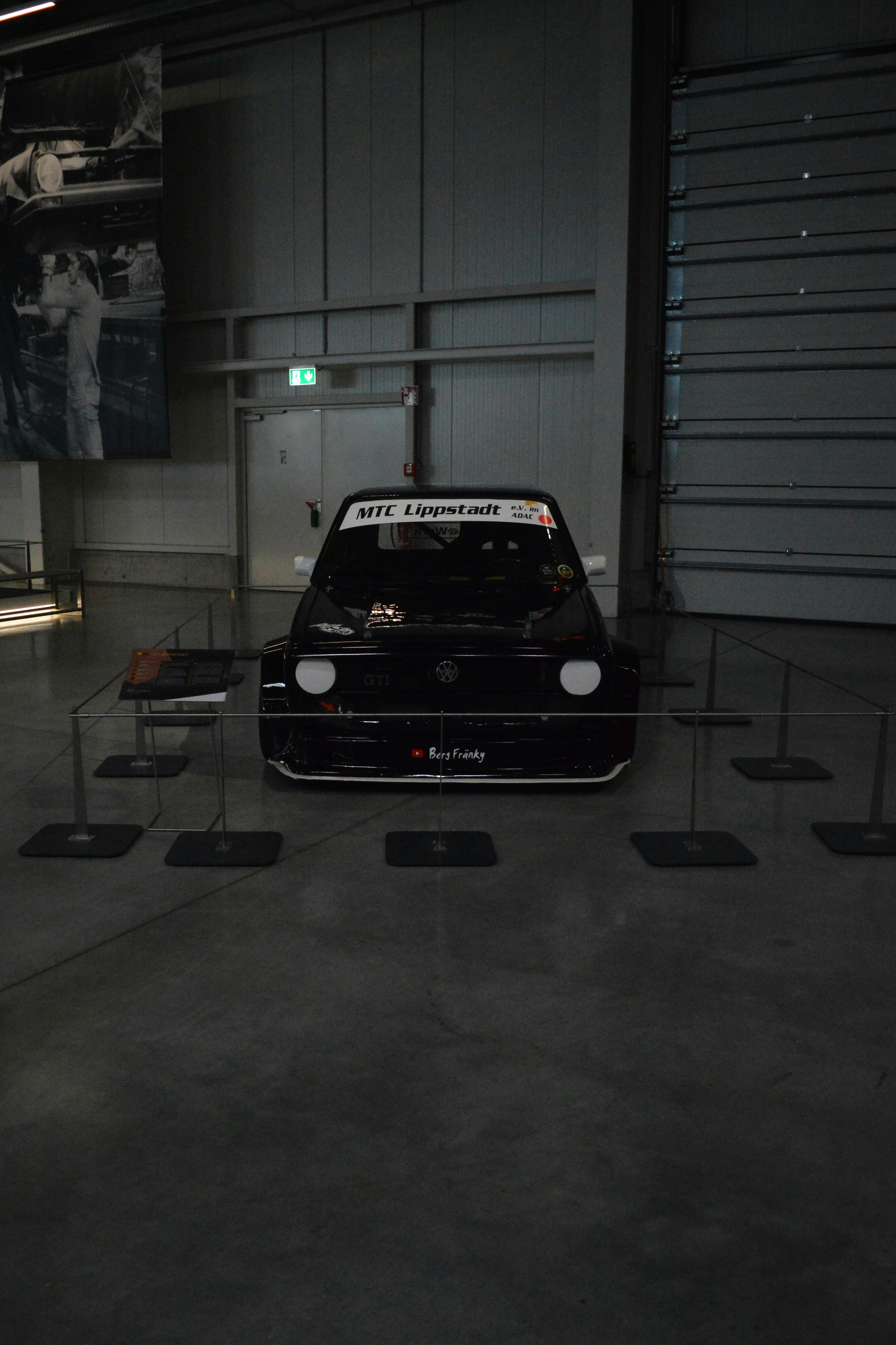 Black Stallion on Display: A Classic Race Car in an Industrial Hall