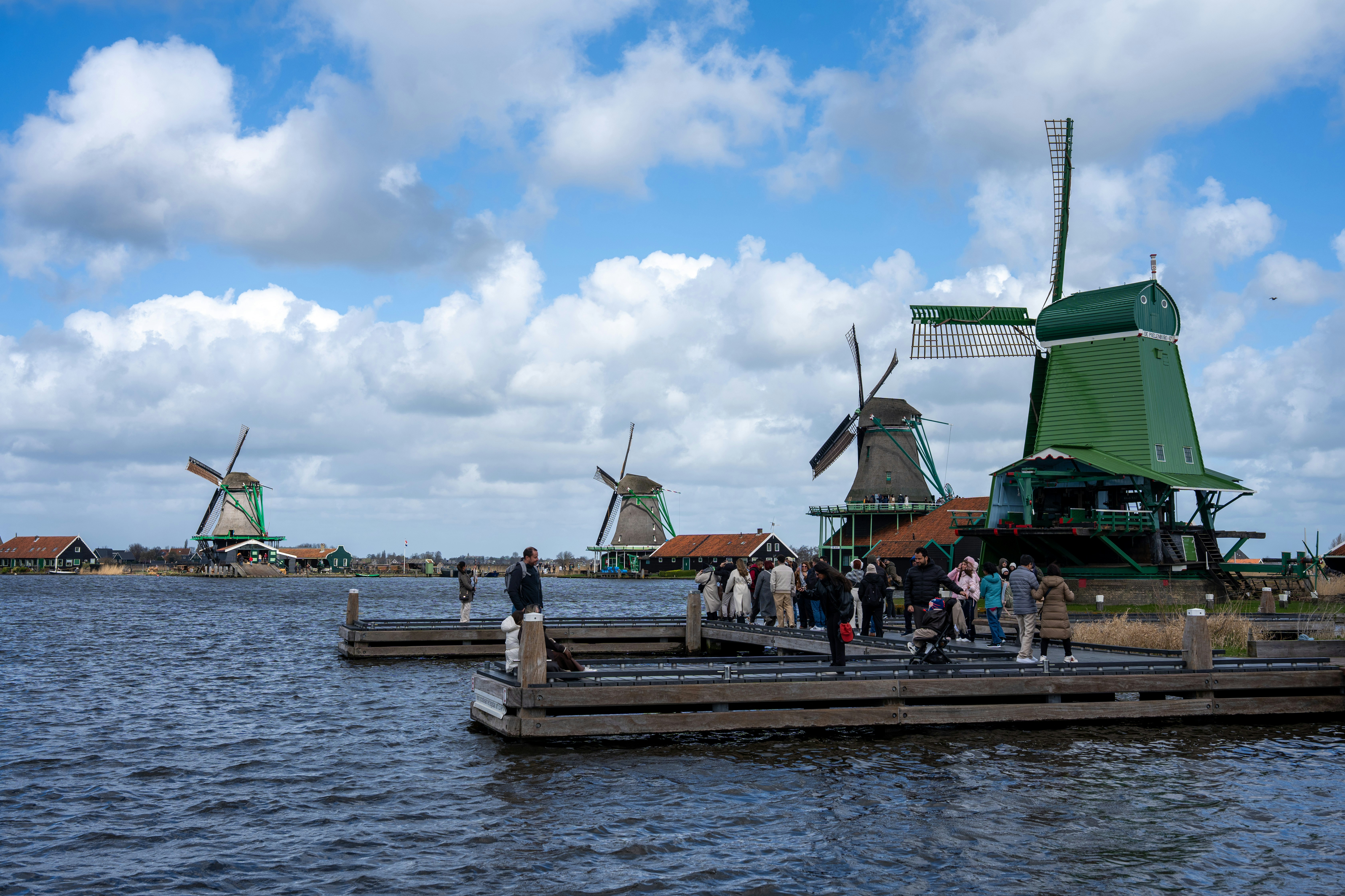 Breezy Riverside: Windmills and Visitors at Zaanse Schans