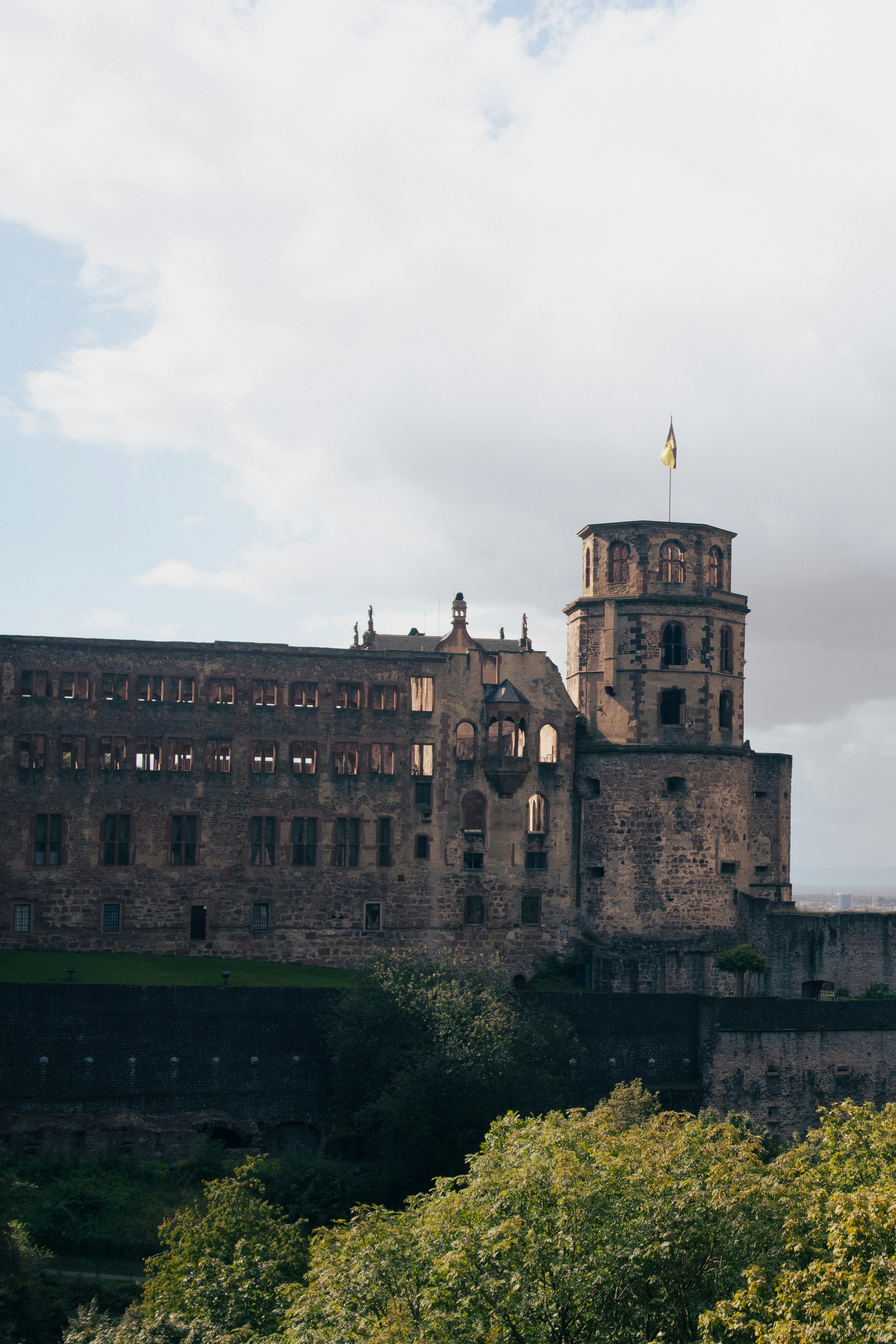 Castle on the Cliffs: Stone Turrets and Flag under Vast Sky
