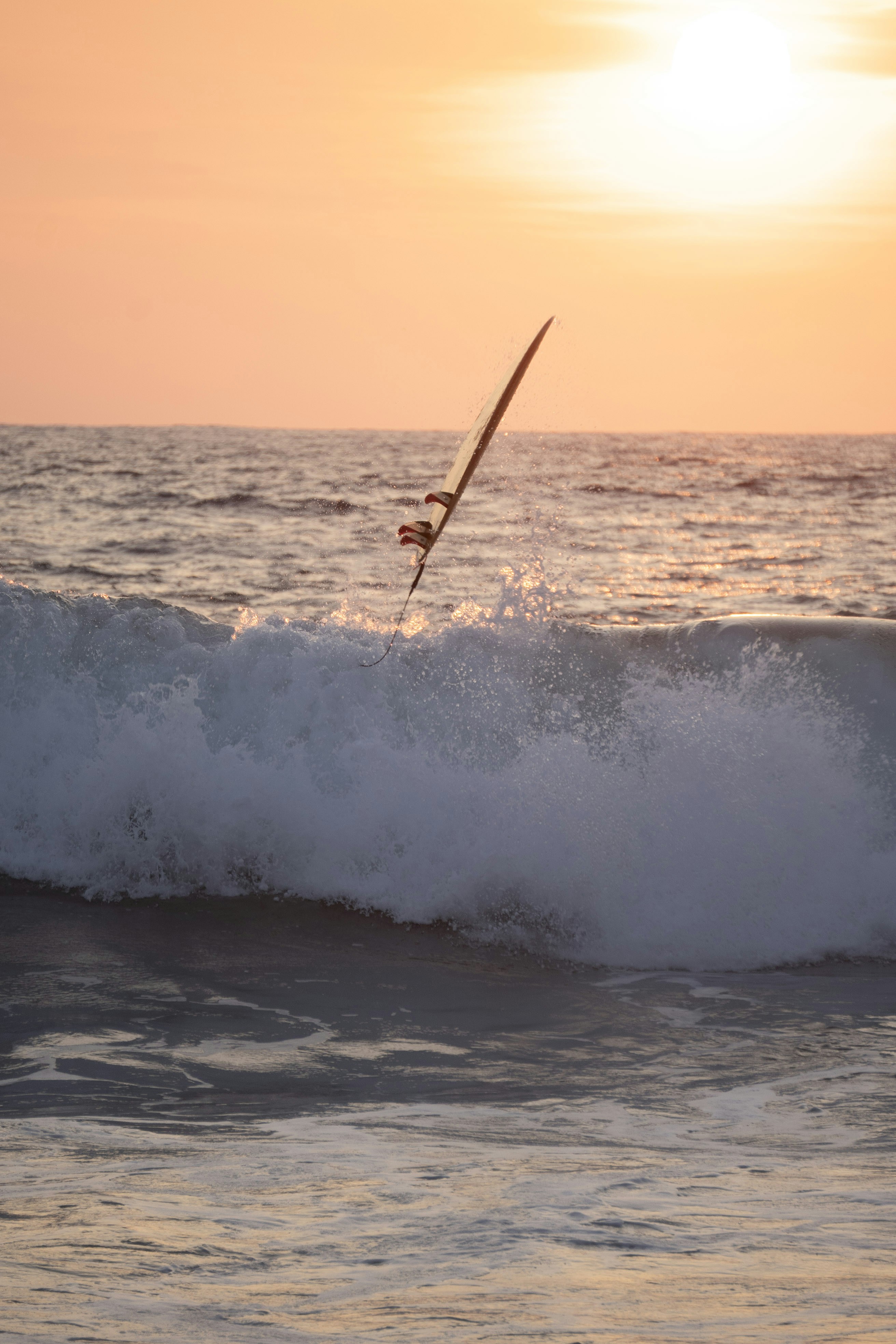 Sunset Surfboard: A Wave Rider Suspended in Golden Light