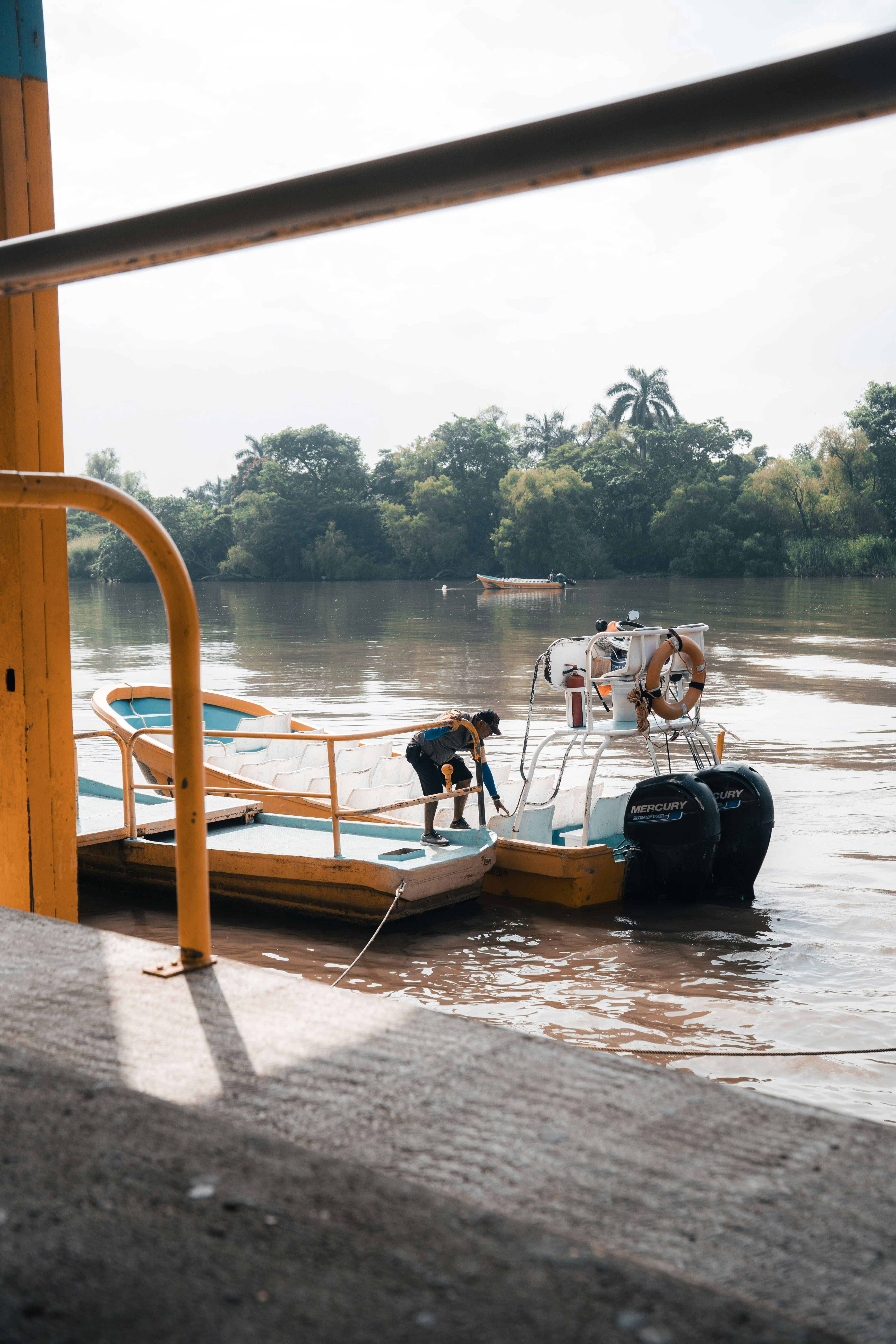 Dockside Work: A Boat Crew Tends to the Motor at Riverside