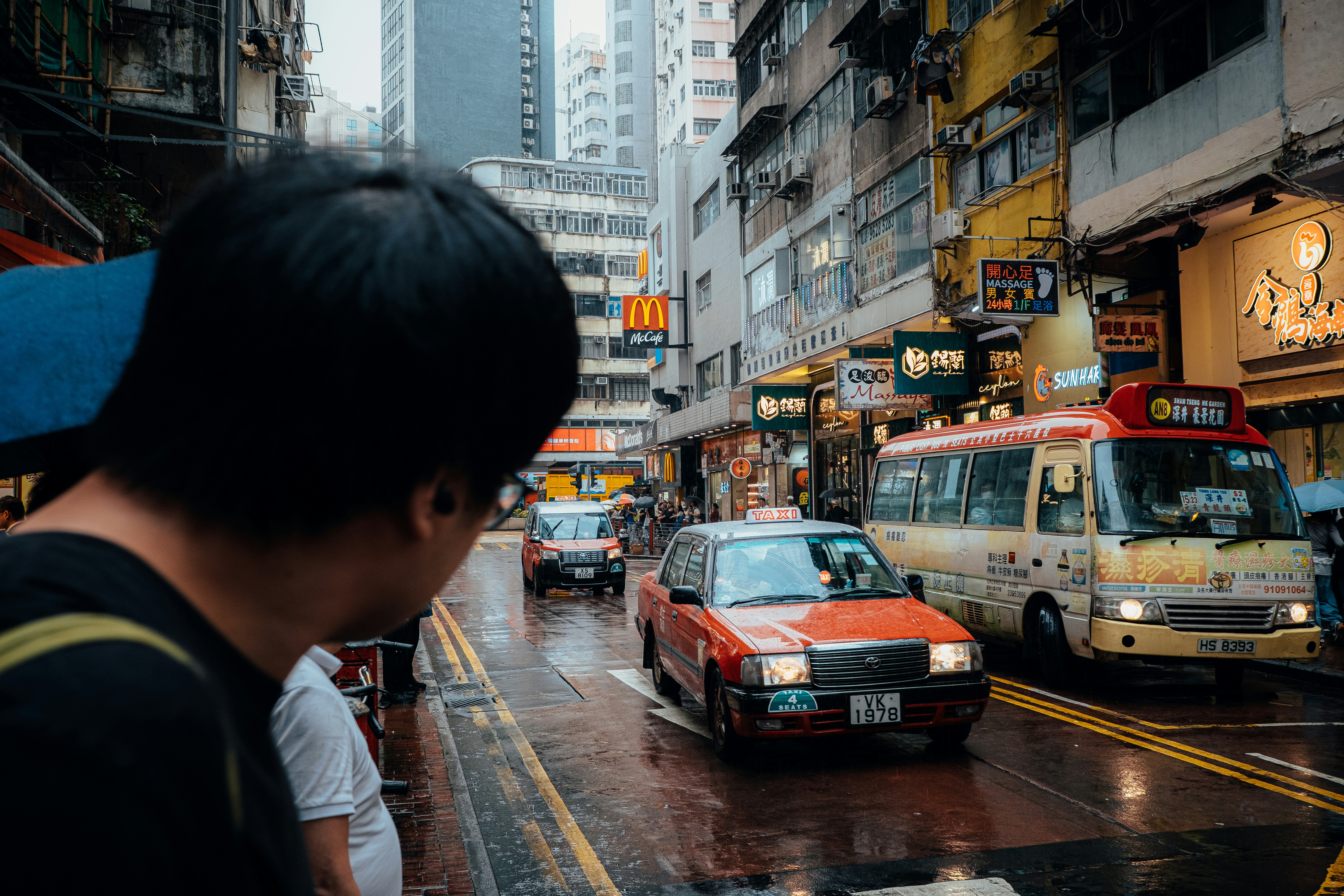 Street Rush: A Pedestrian and Taxi Bang in a Busy HK Lane