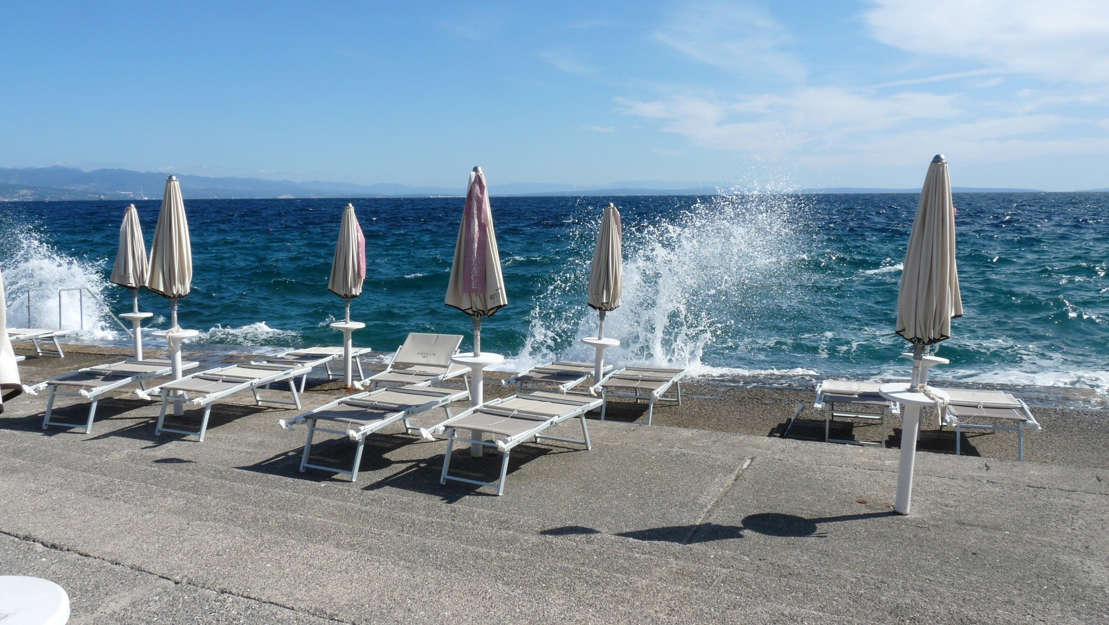 Sunlit Beach Loungers Quietly Facing the Sea