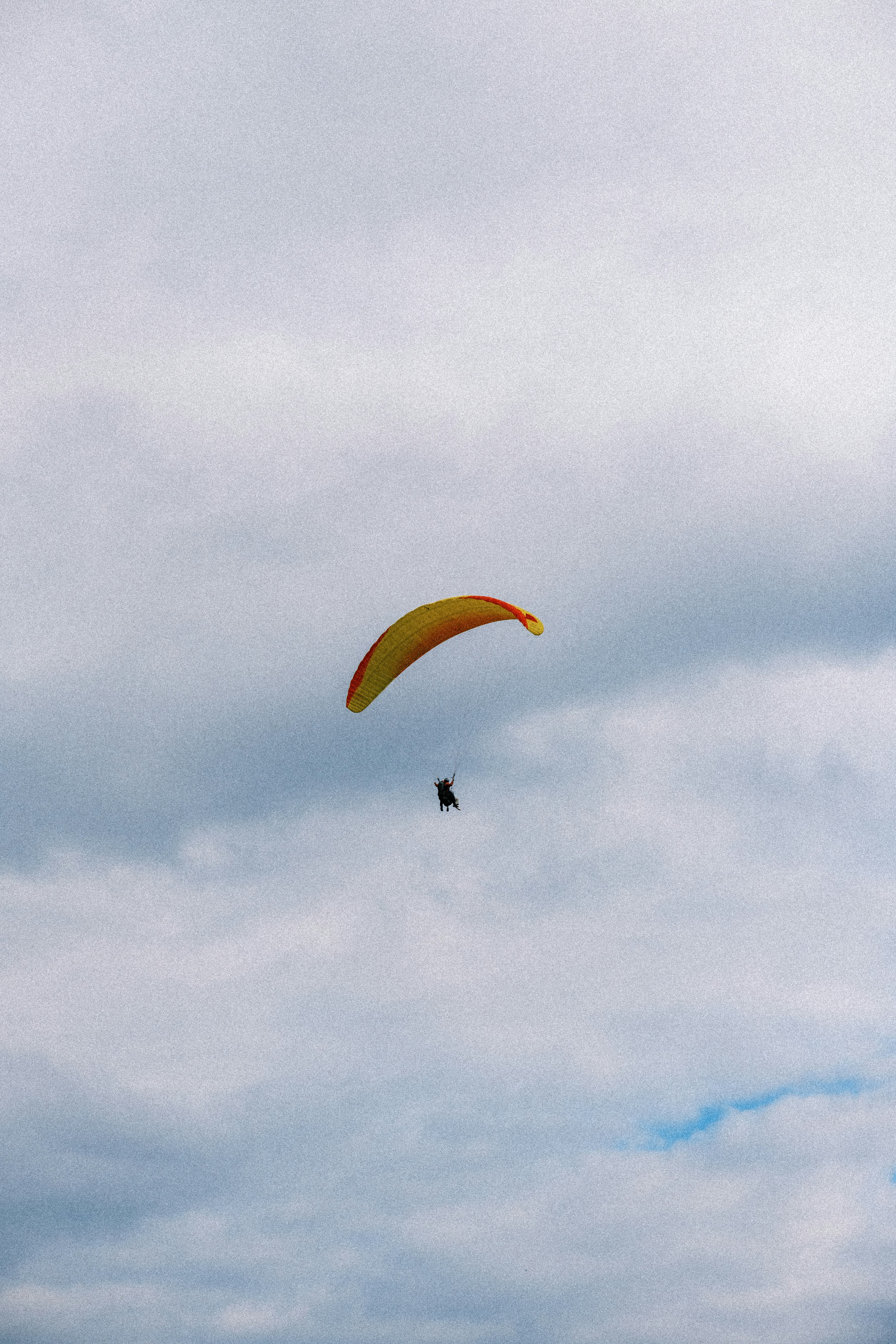Solo Paraglider Against a Subtle Sky