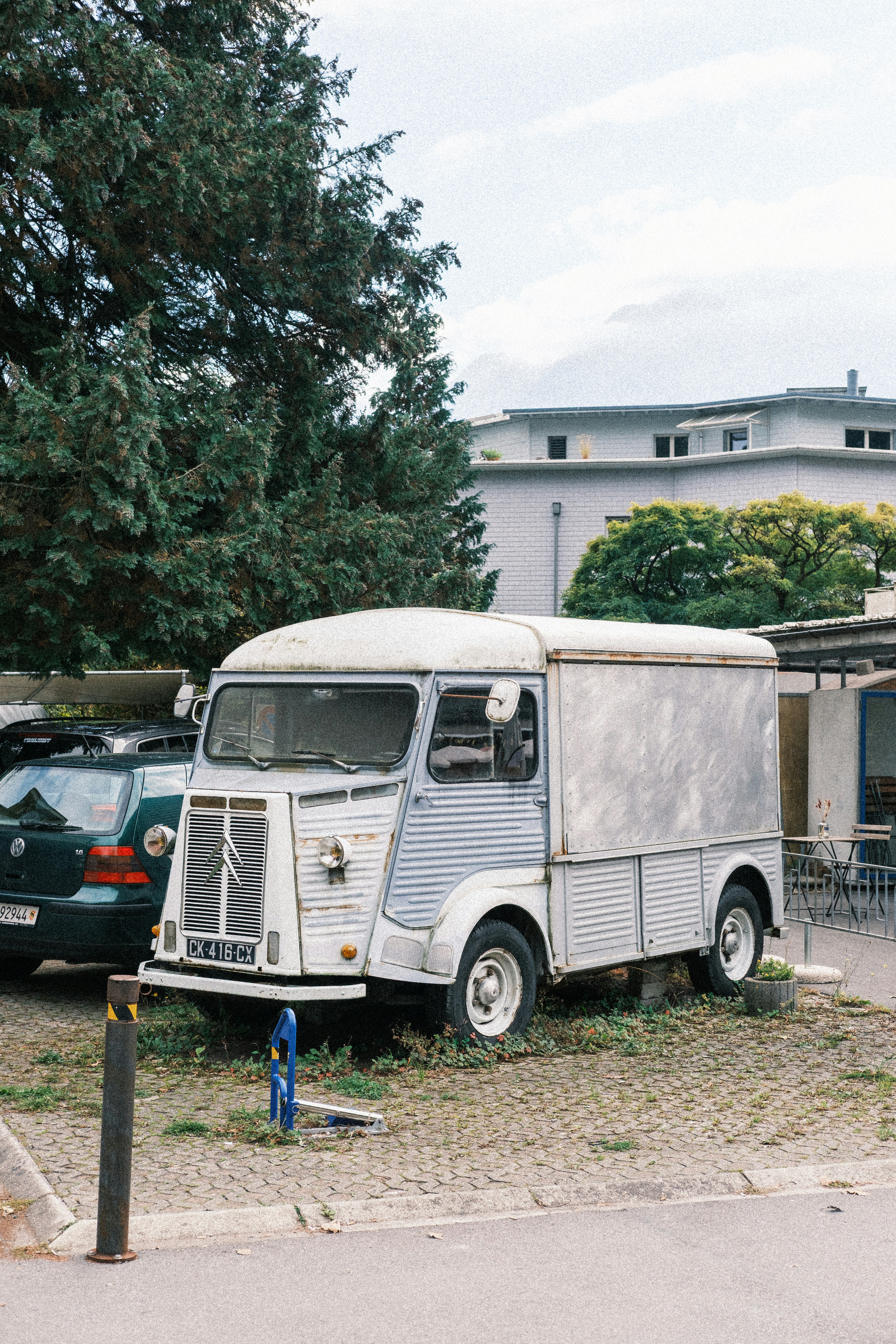 A Weathered Silver Parcel Truck Resting by the Courtyard